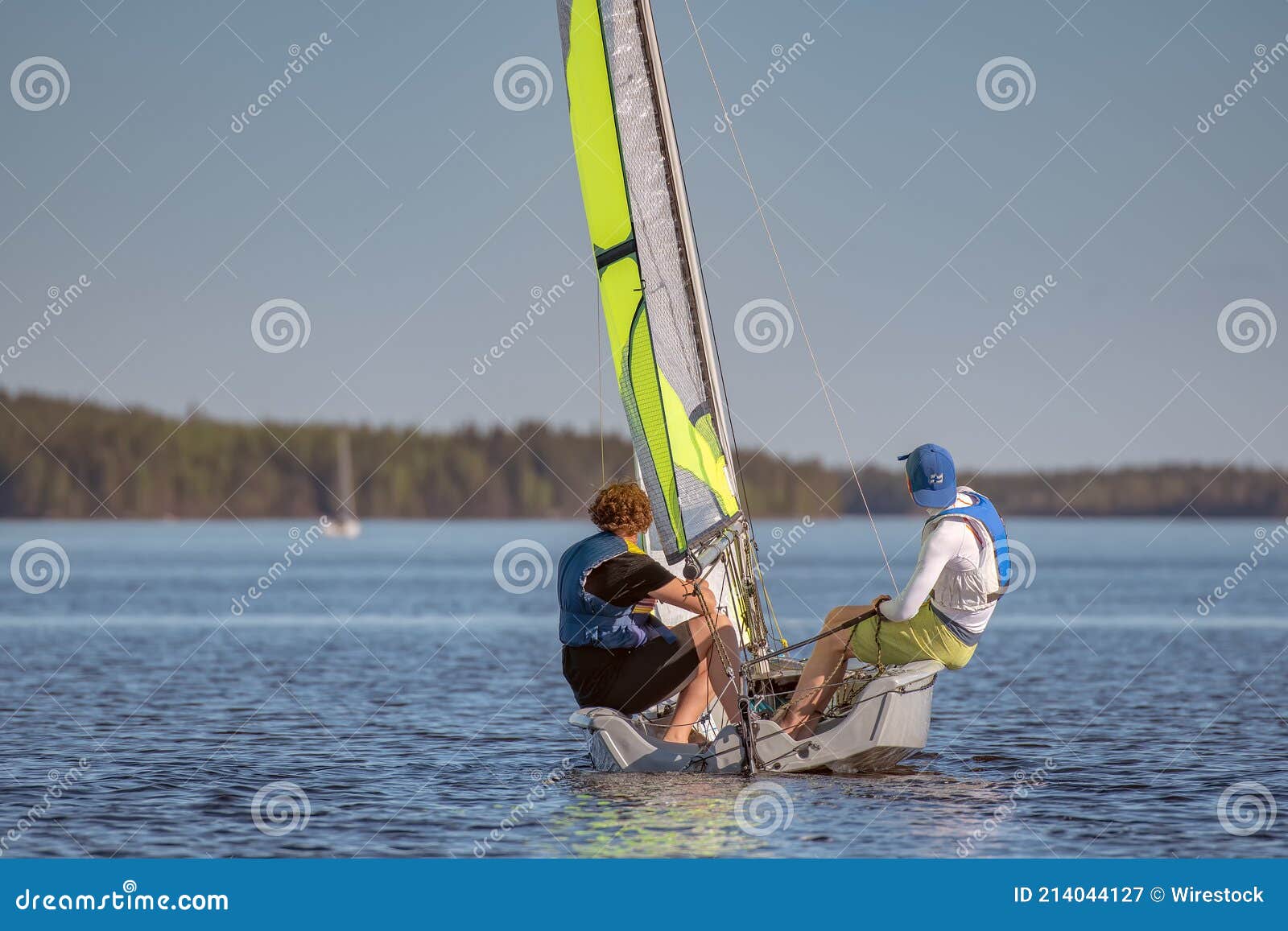 Young Men Sailing on a Calm Lake with Their Dinghy Editorial ...