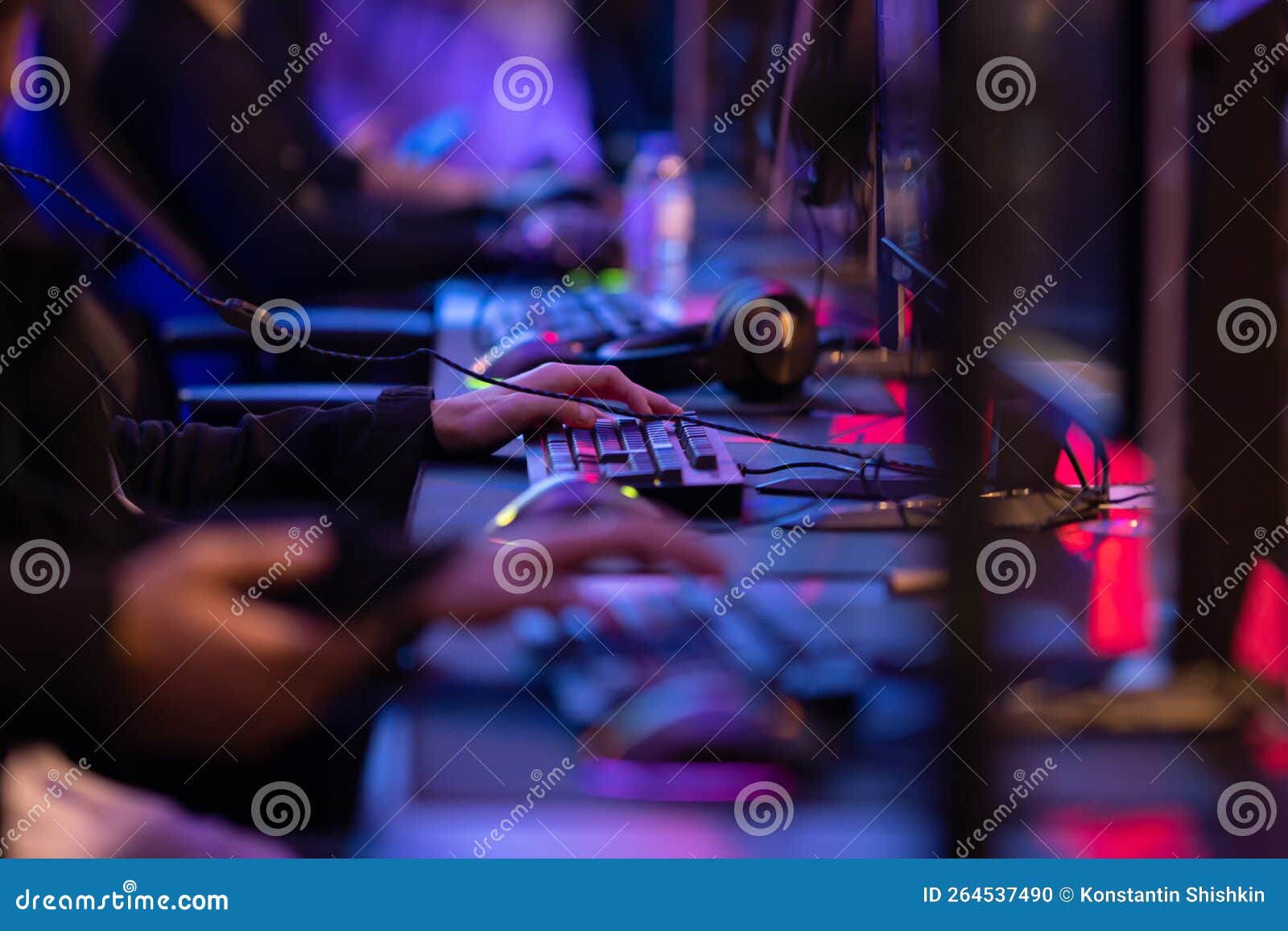 Young Men Sit at Computer Gaming Setups and Playing an Online Game ...