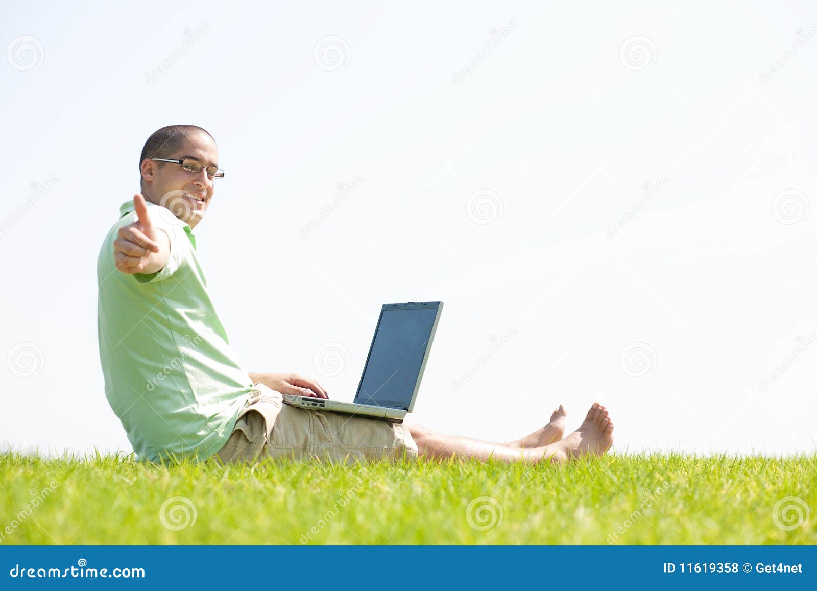 A Young Men Sit on the in the Park Using a Laptop Stock Photo - Image ...