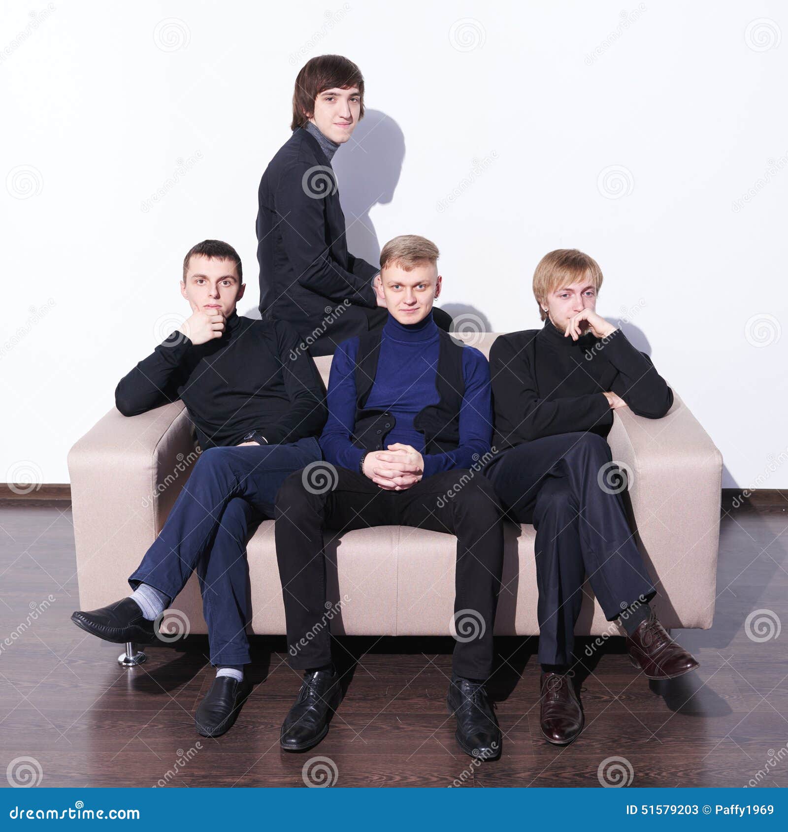 Young Men Sitting on a Sofa Stock Image - Image of holiday, lifestyle ...