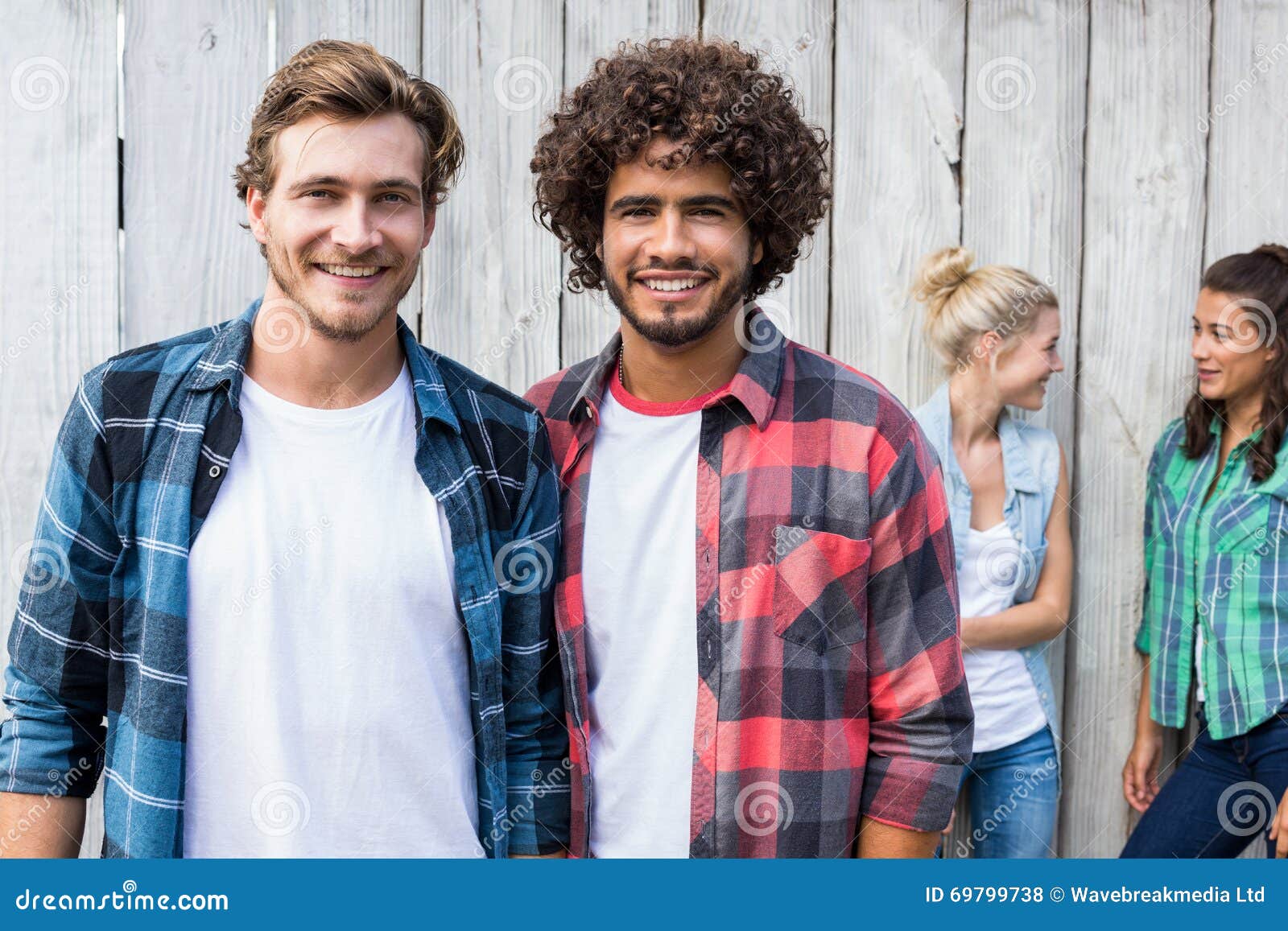 Young Men Smiling at Camera Stock Photo - Image of curly, outdoors ...