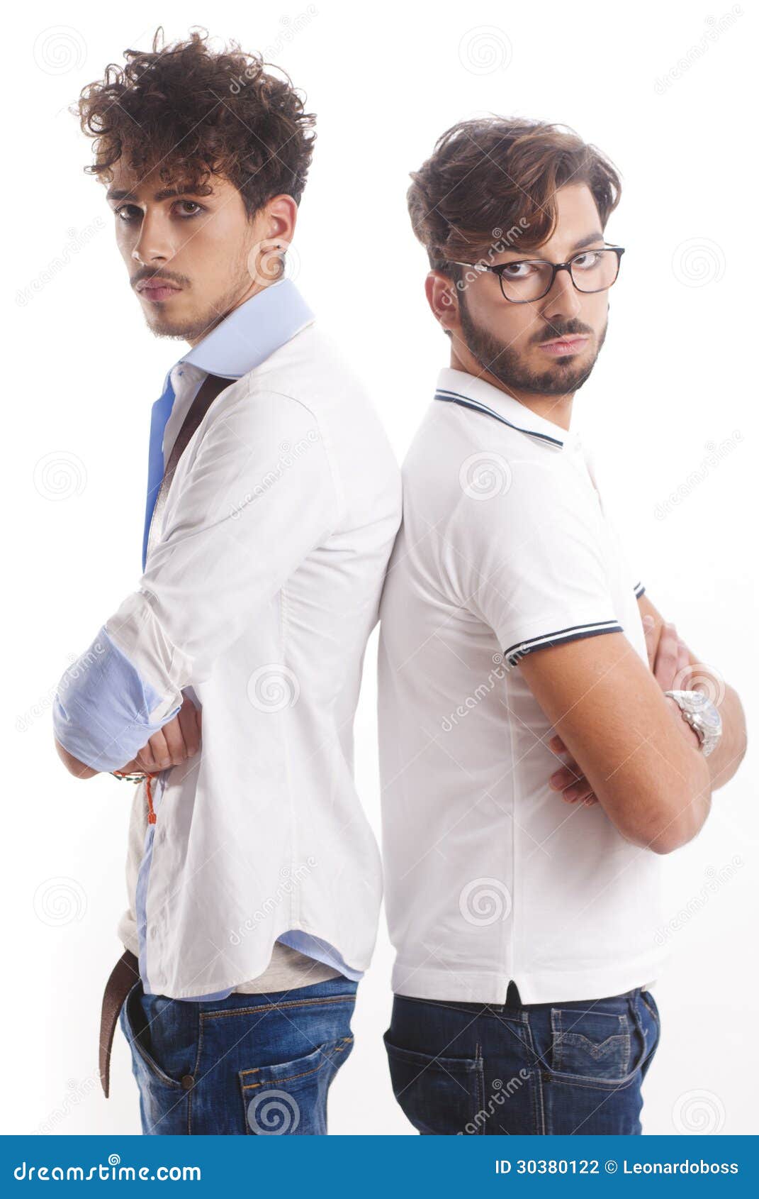 Young Men Standing Back To Back Stock Photo - Image of blonde, looking ...