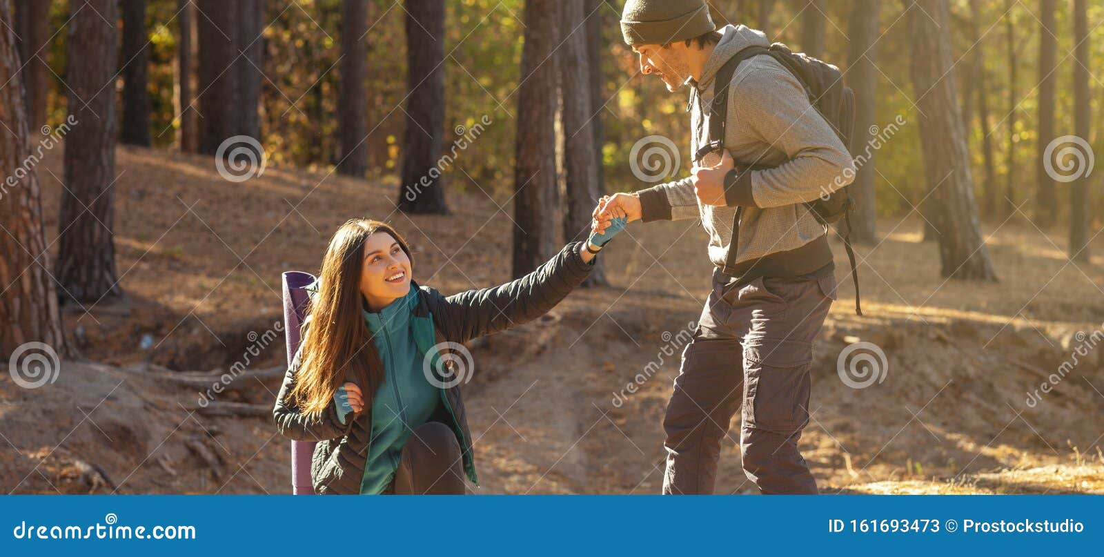 Cropped Image of Man Supporting Woman during Hiking Stock Image - Image ...