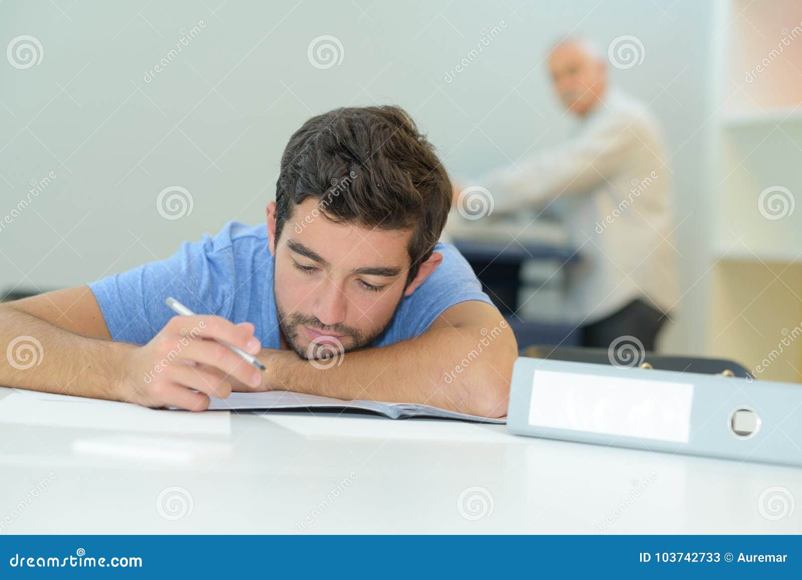 Young man taking exam stock image. Image of writting - 103742733