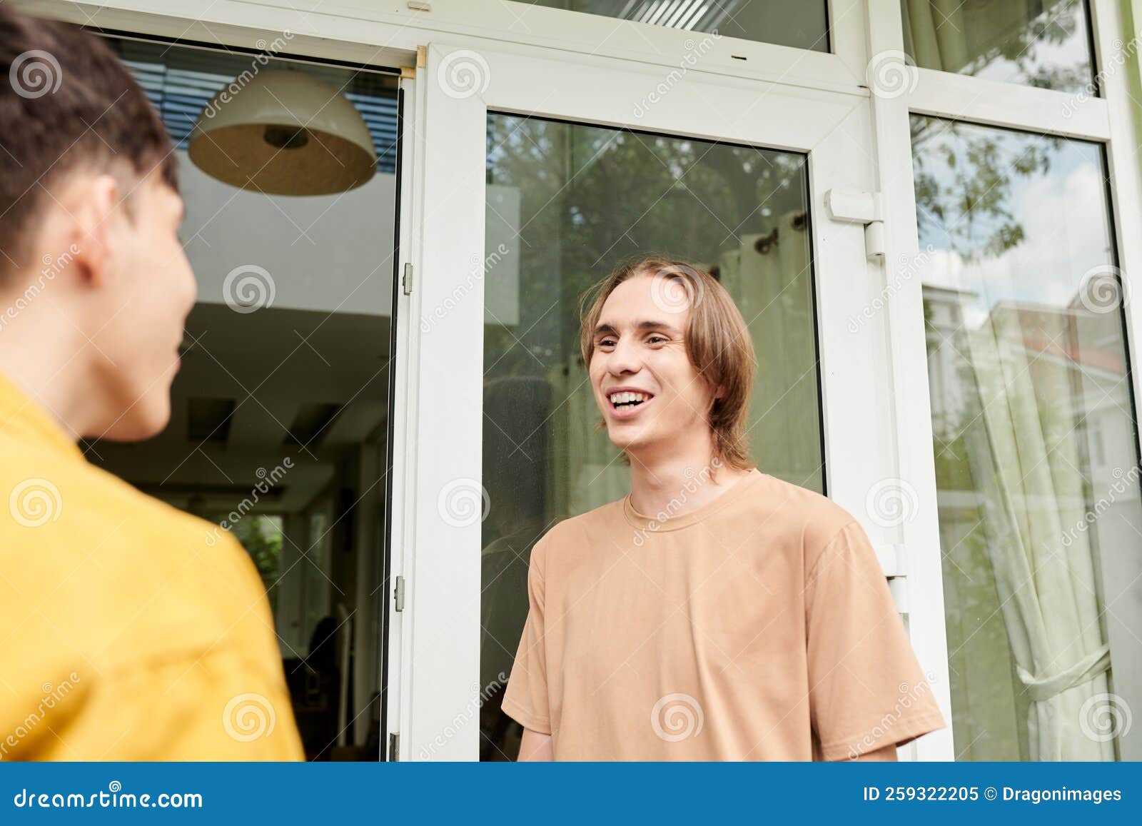 Young Men Talking Outside stock image. Image of greeting - 259322205