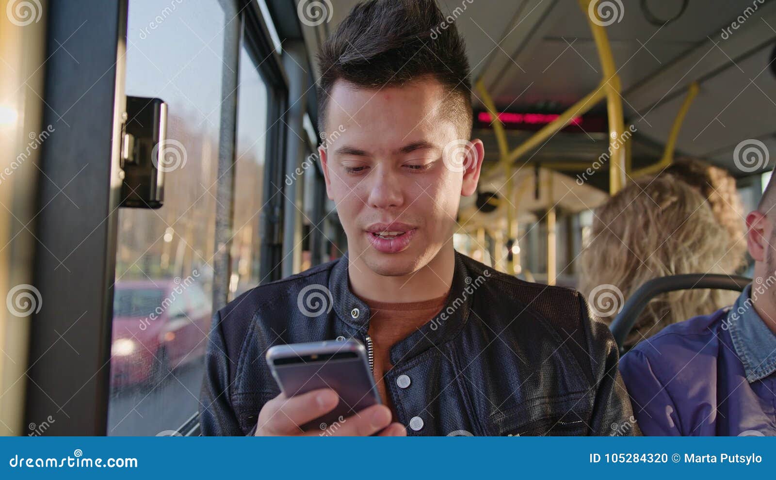 A Young Man Using a Smartphone on the Bus Stock Photo - Image of ...