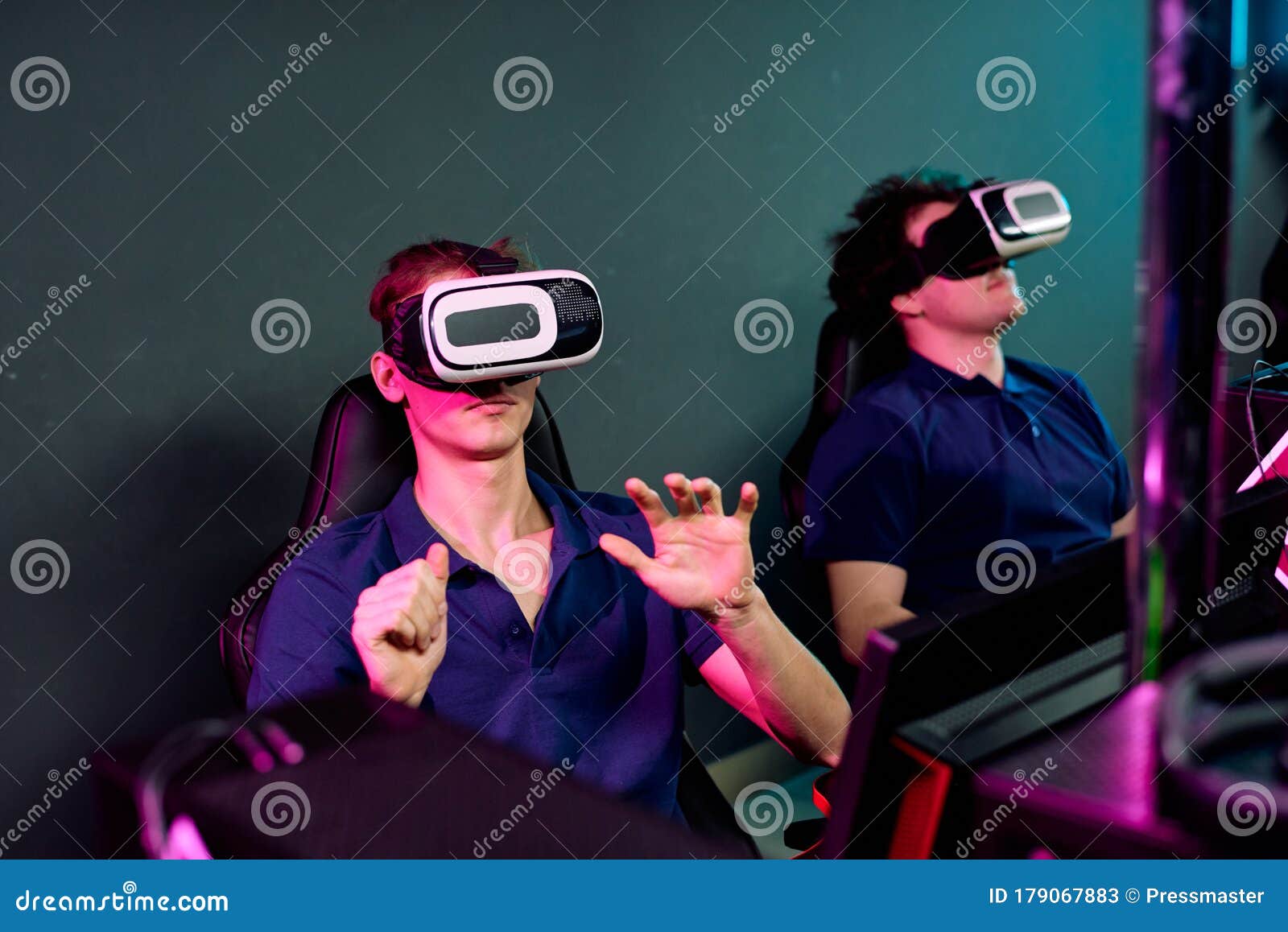 Young Men Using Virtual Reality Simulators Stock Image - Image of video ...