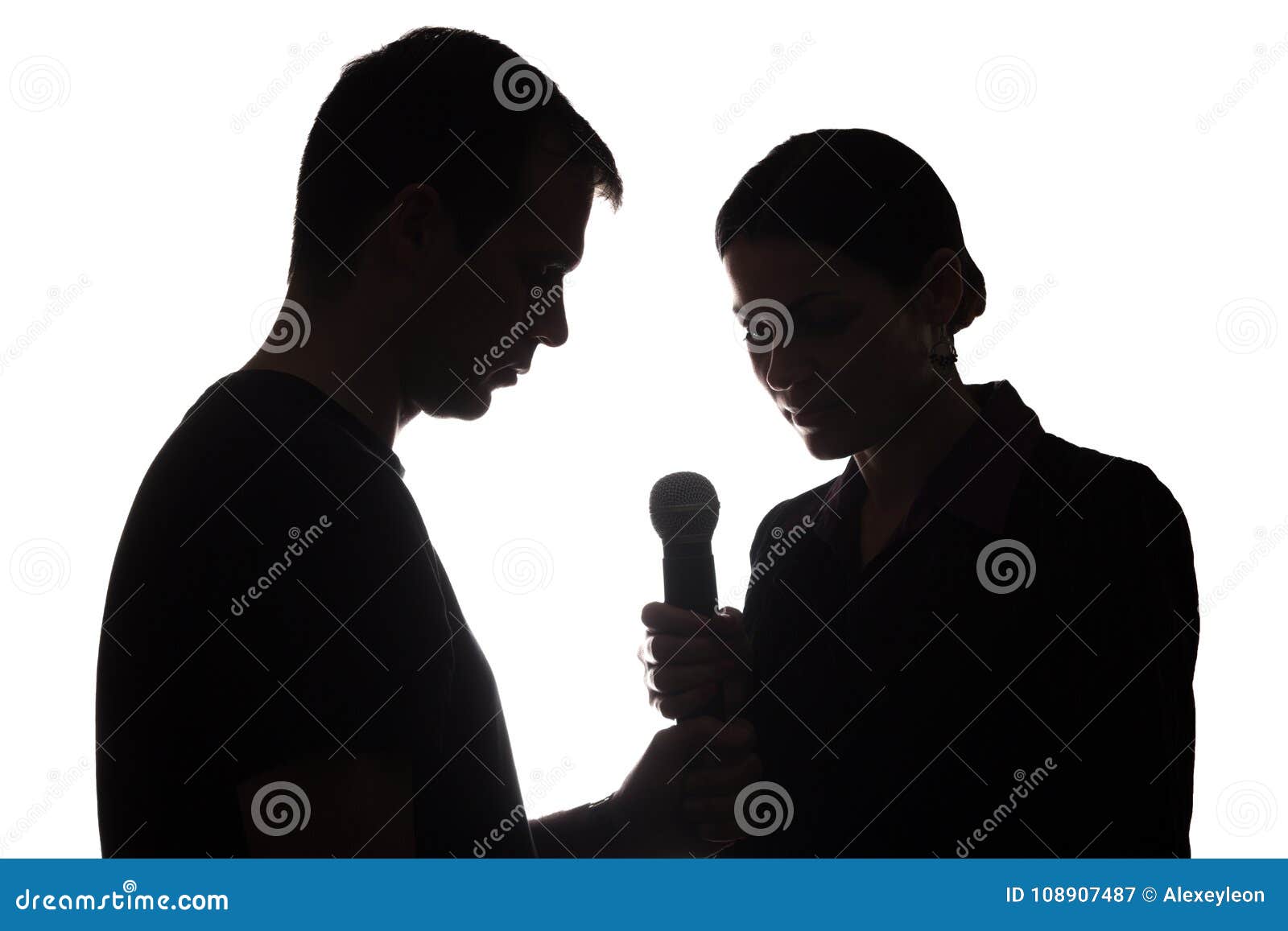 Young Man And Woman Singing Into The Microphone Stock Image Image Of
