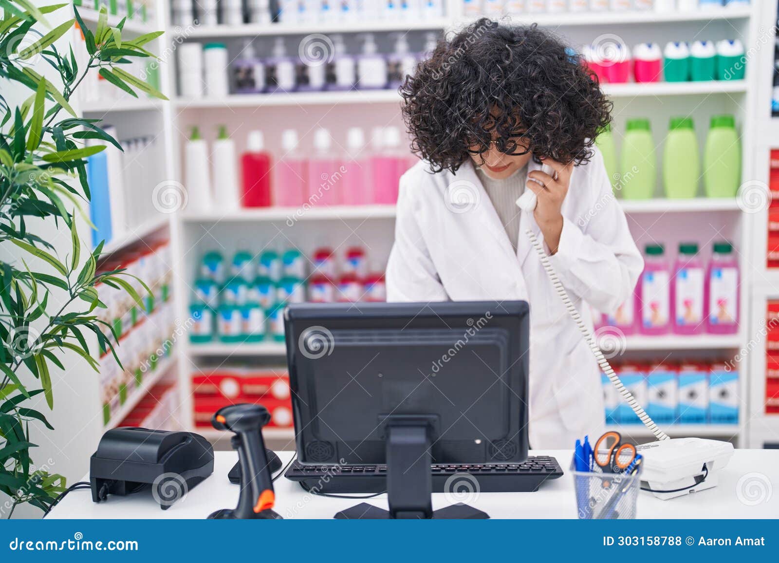 Young Middle Eastern Woman Pharmacist Talking on Telephone Using ...