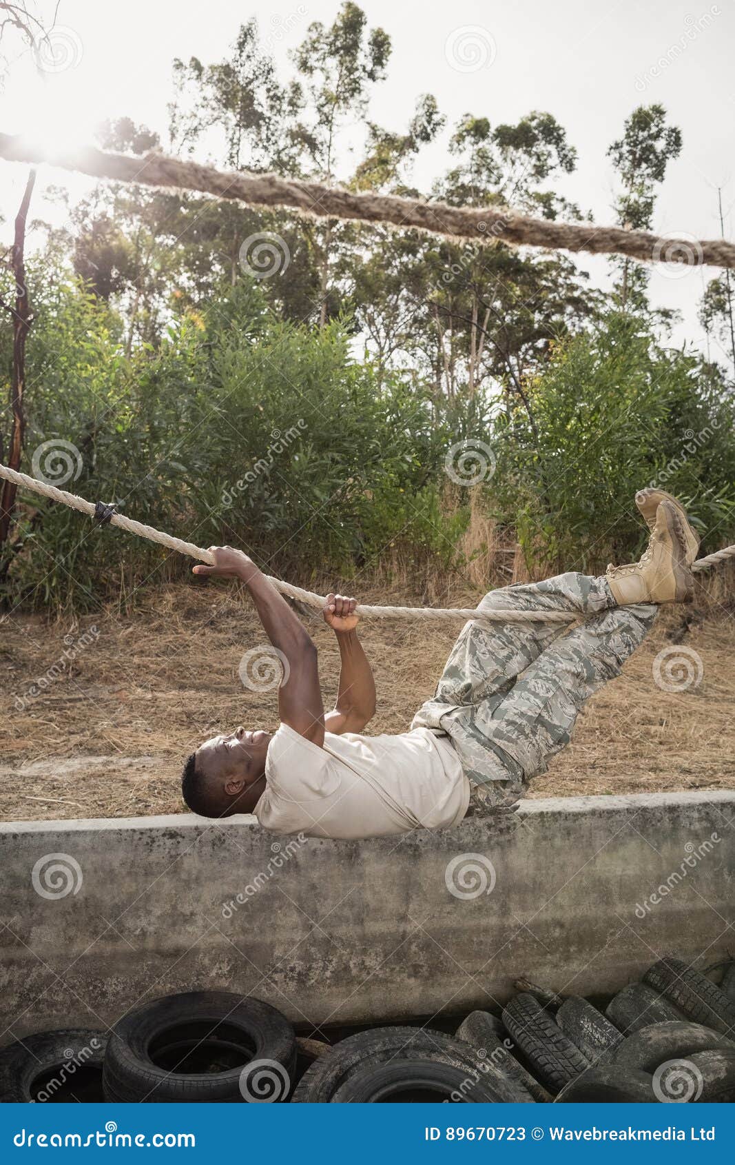 Young Military Soldier Practicing Rope Climbing during Obstacle Course ...