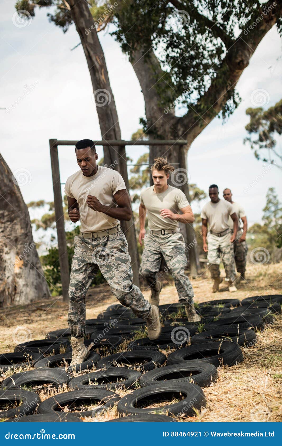 Young Military Soldiers Practicing Tyre Obstacle Course Stock Image ...