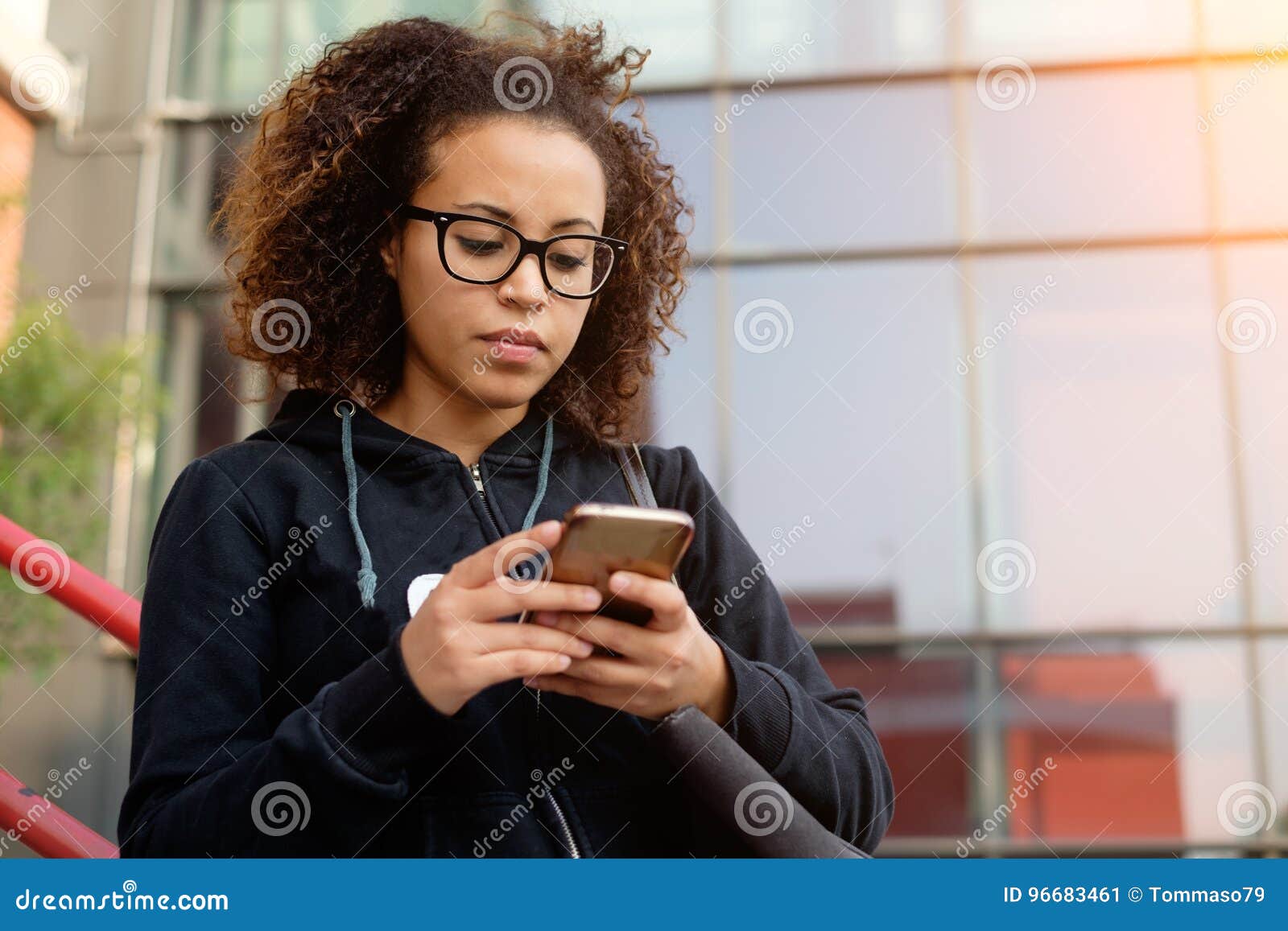 Young Millennial Girl Texting on Her Phone Stock Image - Image of ...