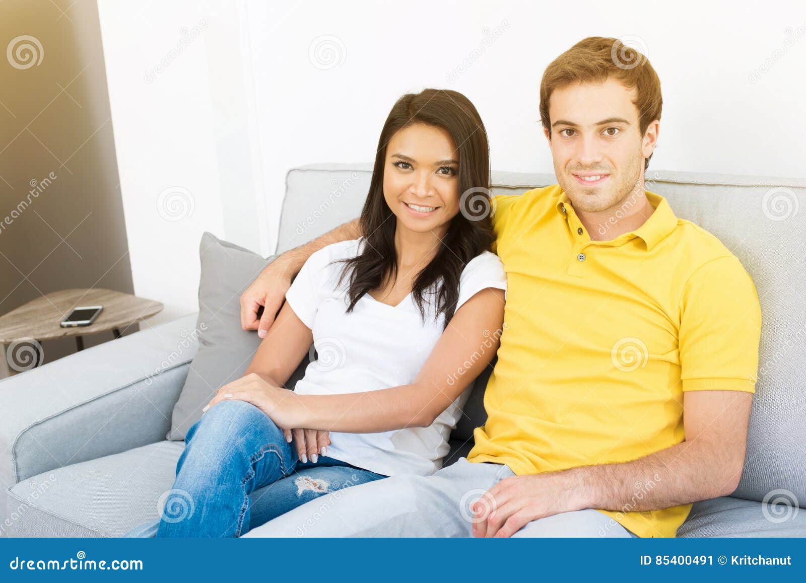 Young Mixed Race Couple Sitting On The Couch Stock Image Image Of