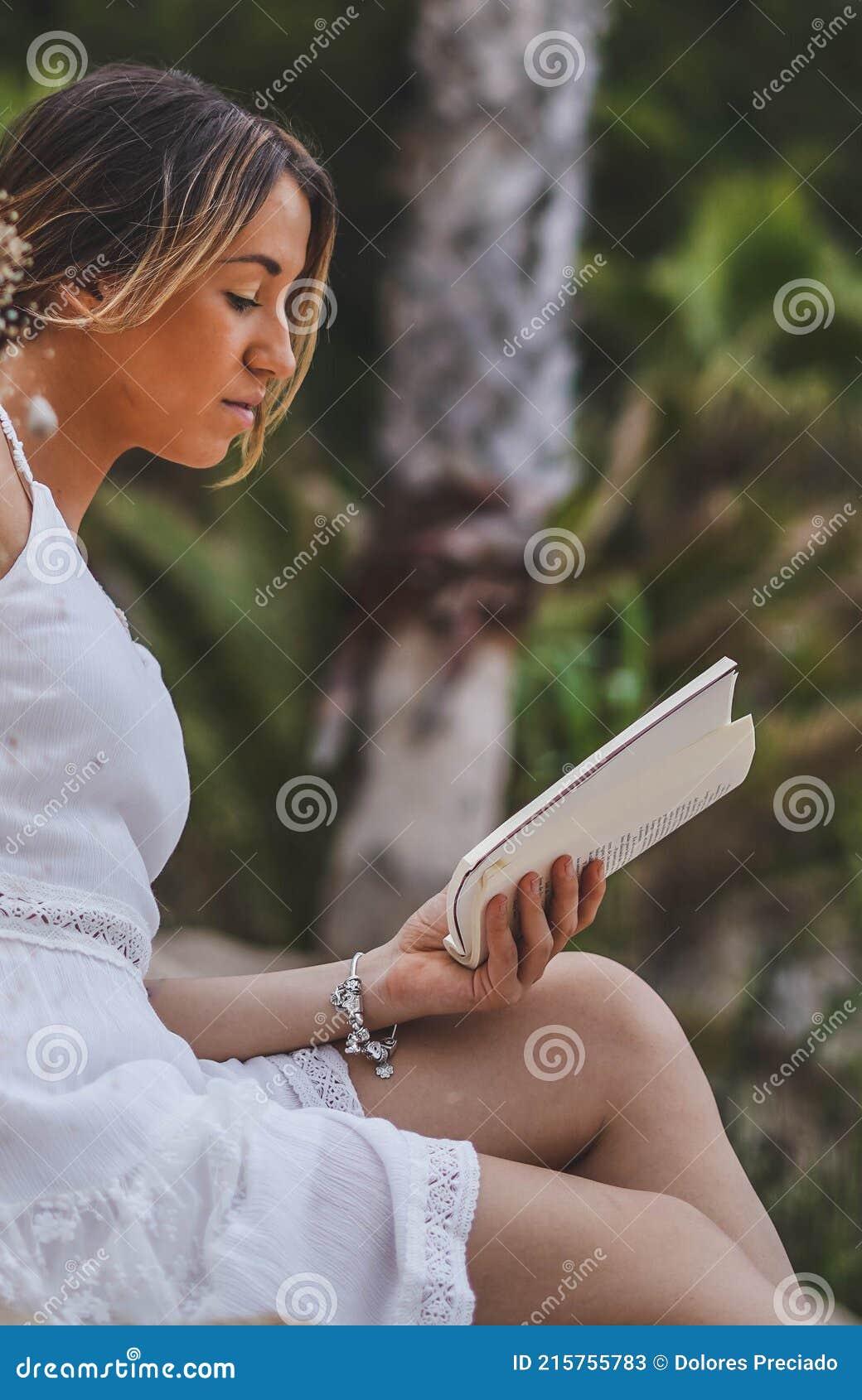 Young Model Posing in a Summer Dress and Reading a Book Stock Image ...