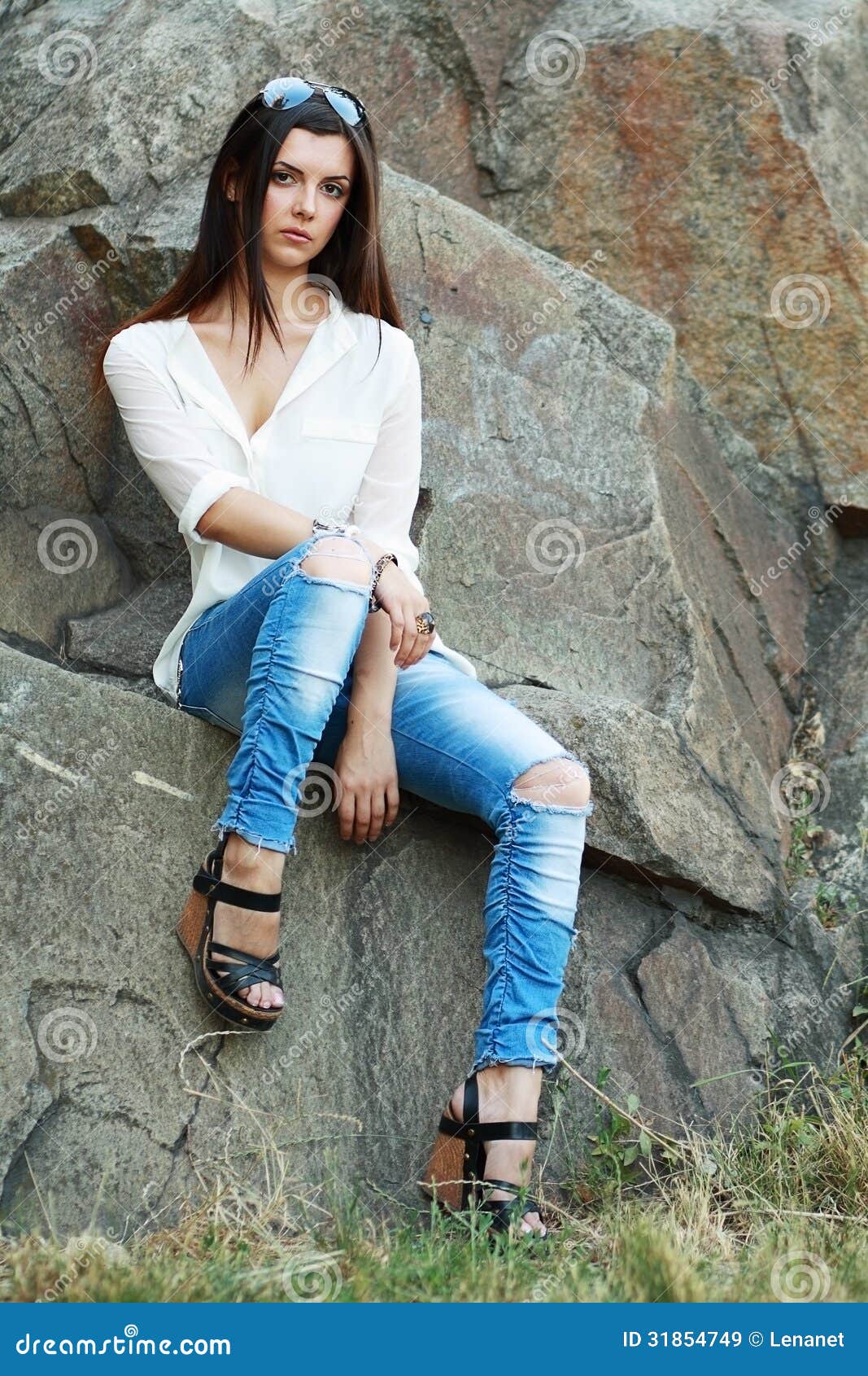 Young model sits on stones stock image. Image of long - 31854749