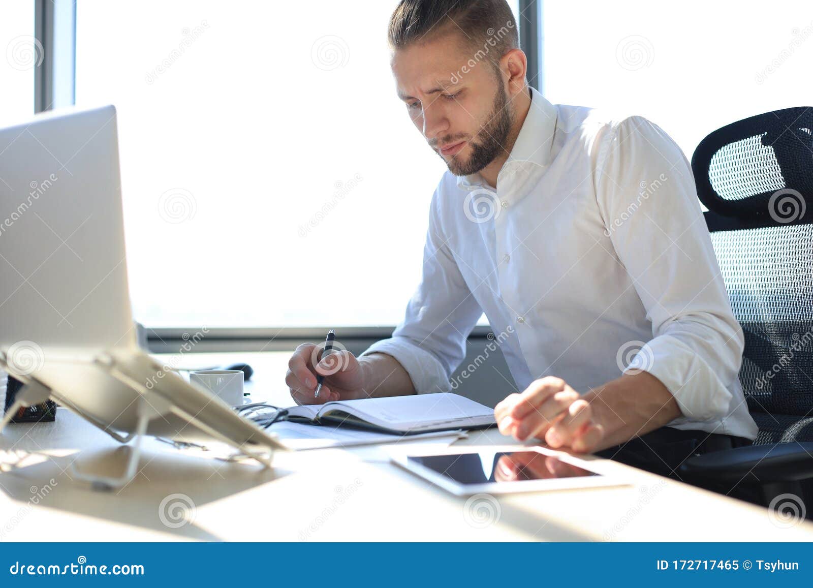 Young Modern Business Man Analyzing Data Using Laptop While Working In