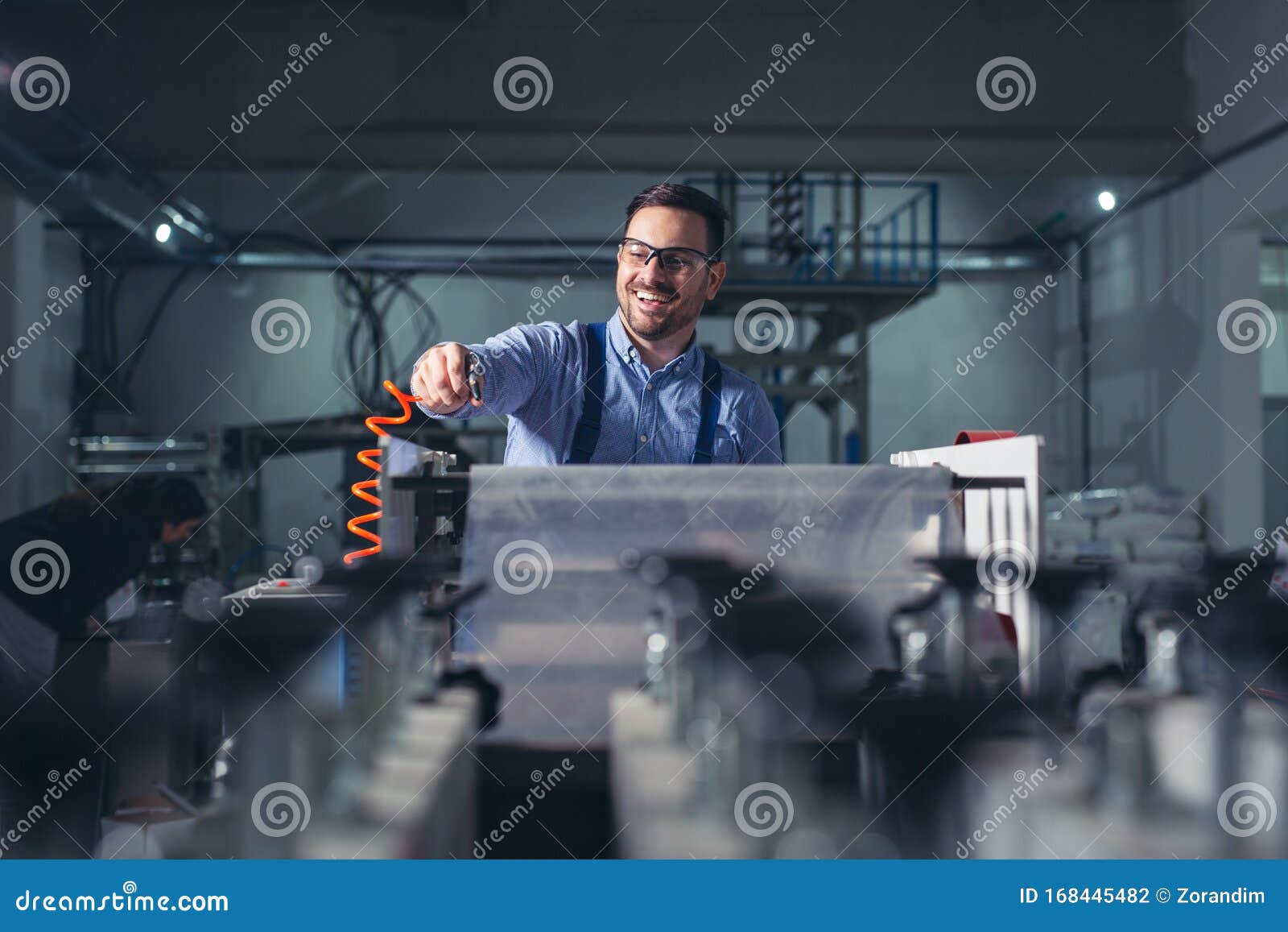 Modern Industrial Machine Operator Working in Factory. Worker on the ...
