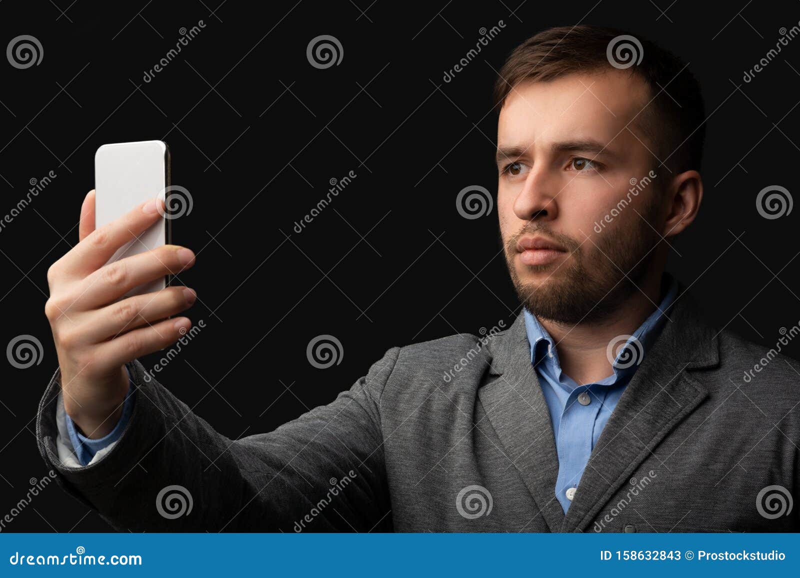Young Modern Man In Suit Using Facial Recognition On Smartphone Stock