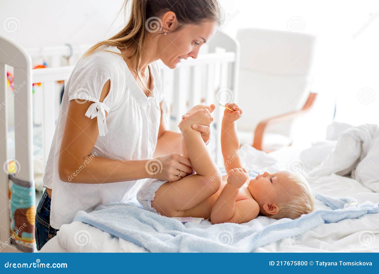 Young Mom, Changing Baby Diaper after Bath Stock Photo - Image of ...