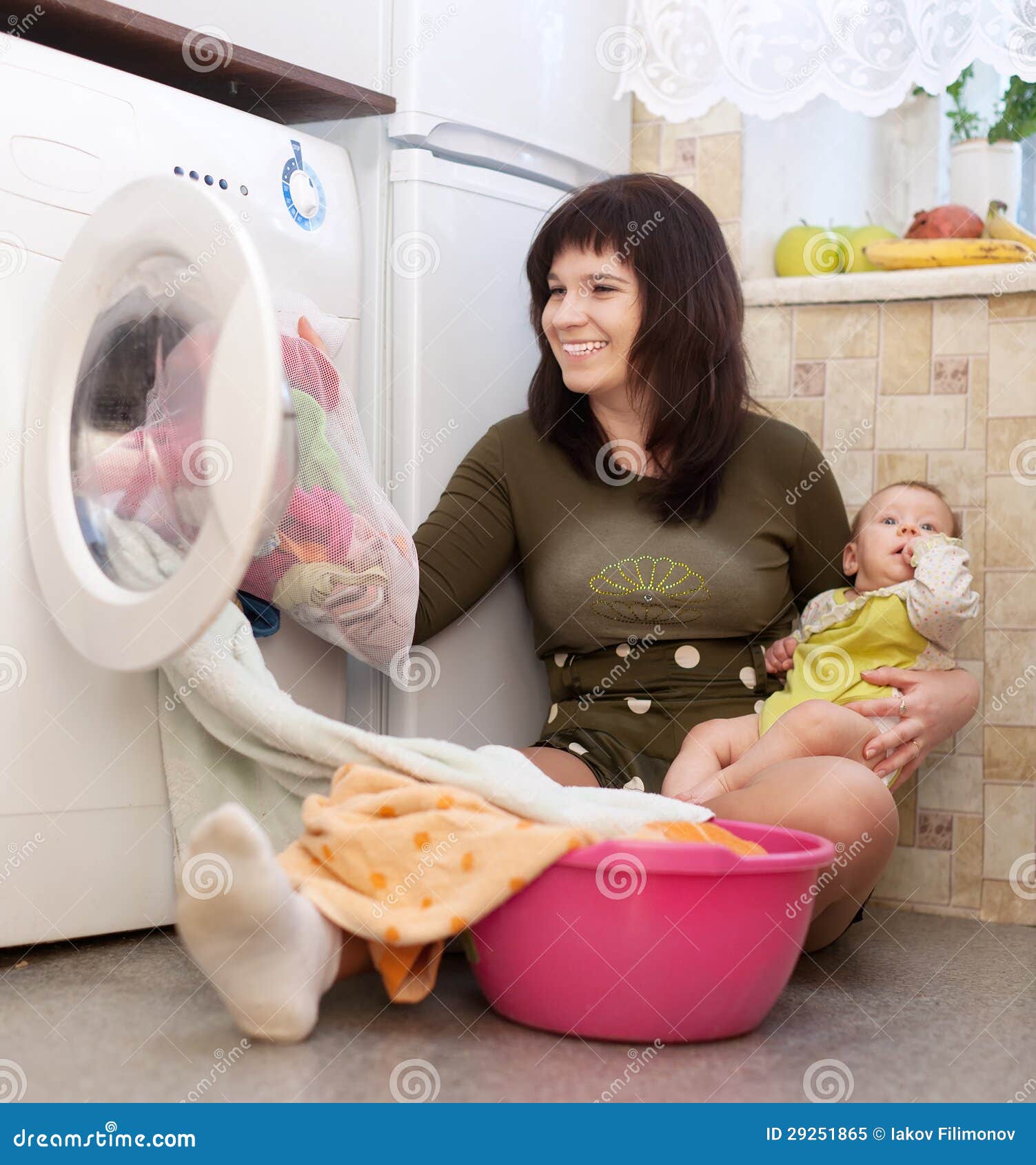 Young Mother with Baby Doing Laundry Stock Image - Image of baby ...
