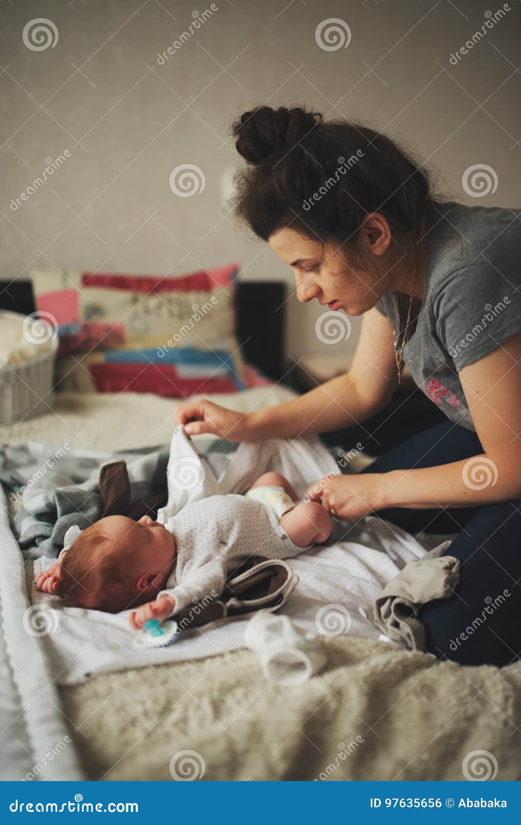 Mother Change Clothes To Her Baby. Cute Baby Wearing Dress Royalty-Free ...