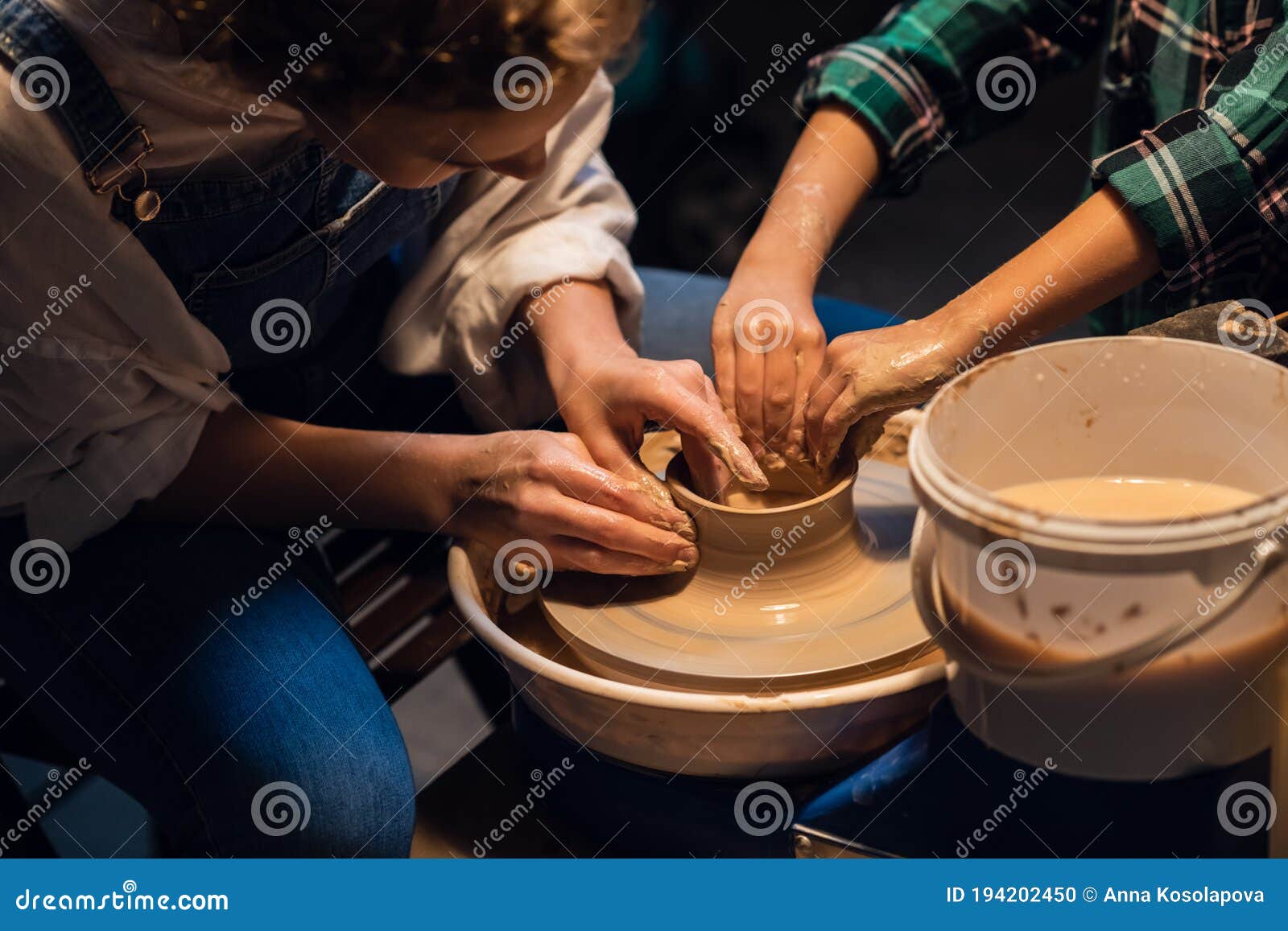 A Young Mother with a Charming Son in a Pottery Workshop Sculpting a ... A Young Mother with a Charming Son in a Pottery Workshop Sculpting a ...