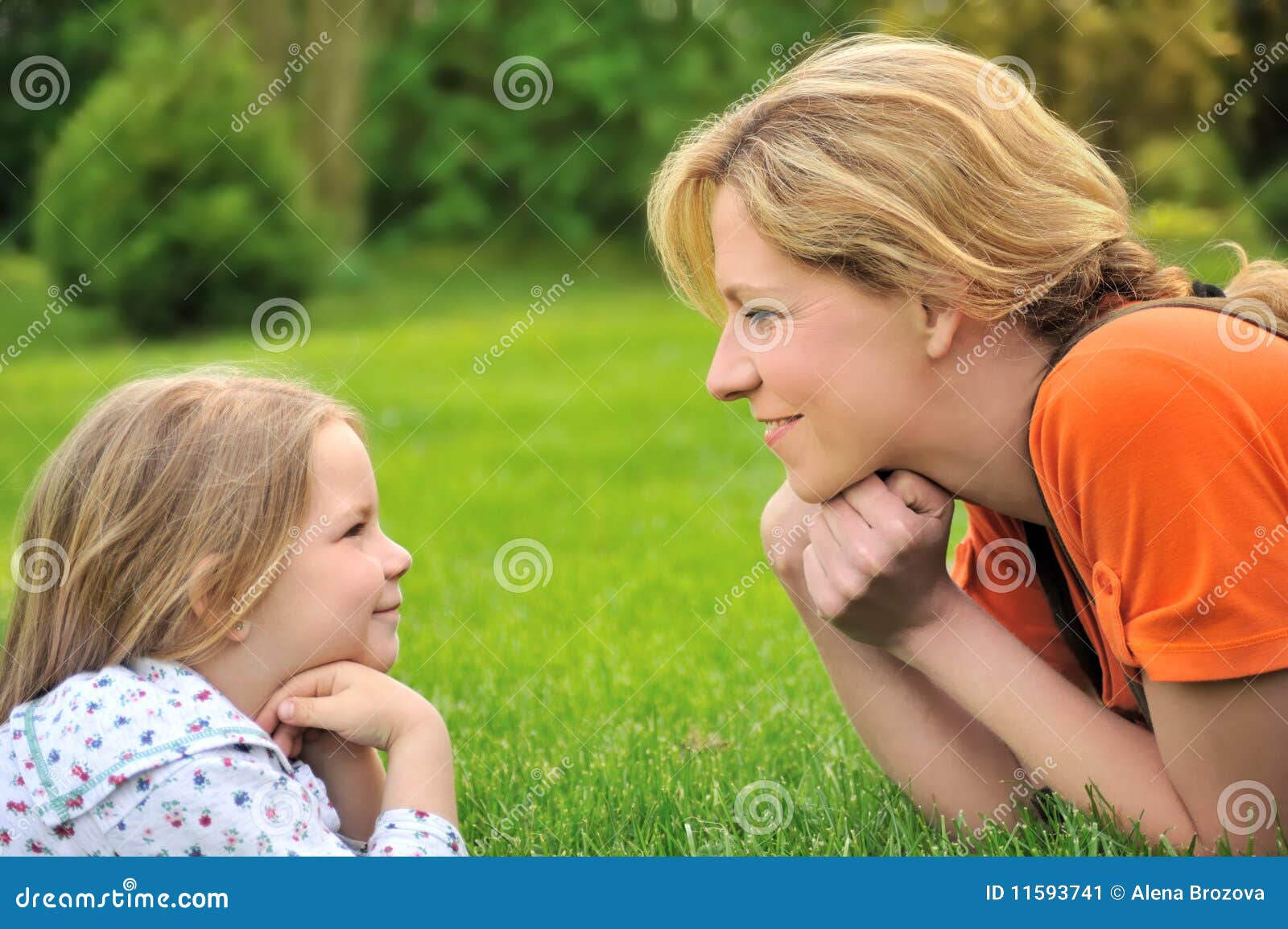 Young Mother And Daughter Laying On The Grass Stock Image