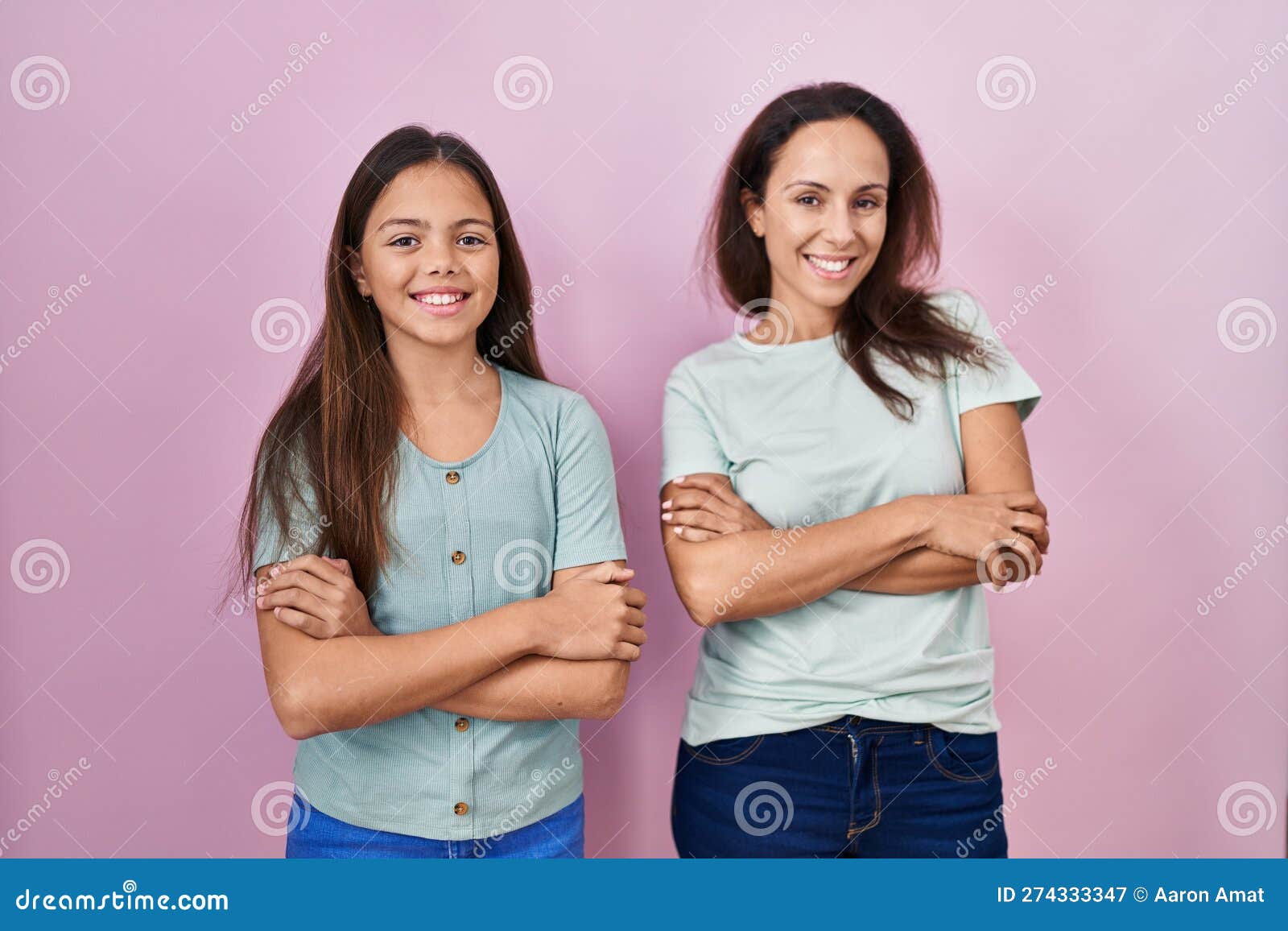 Young Mother And Daughter Standing Over Pink Background Happy Face