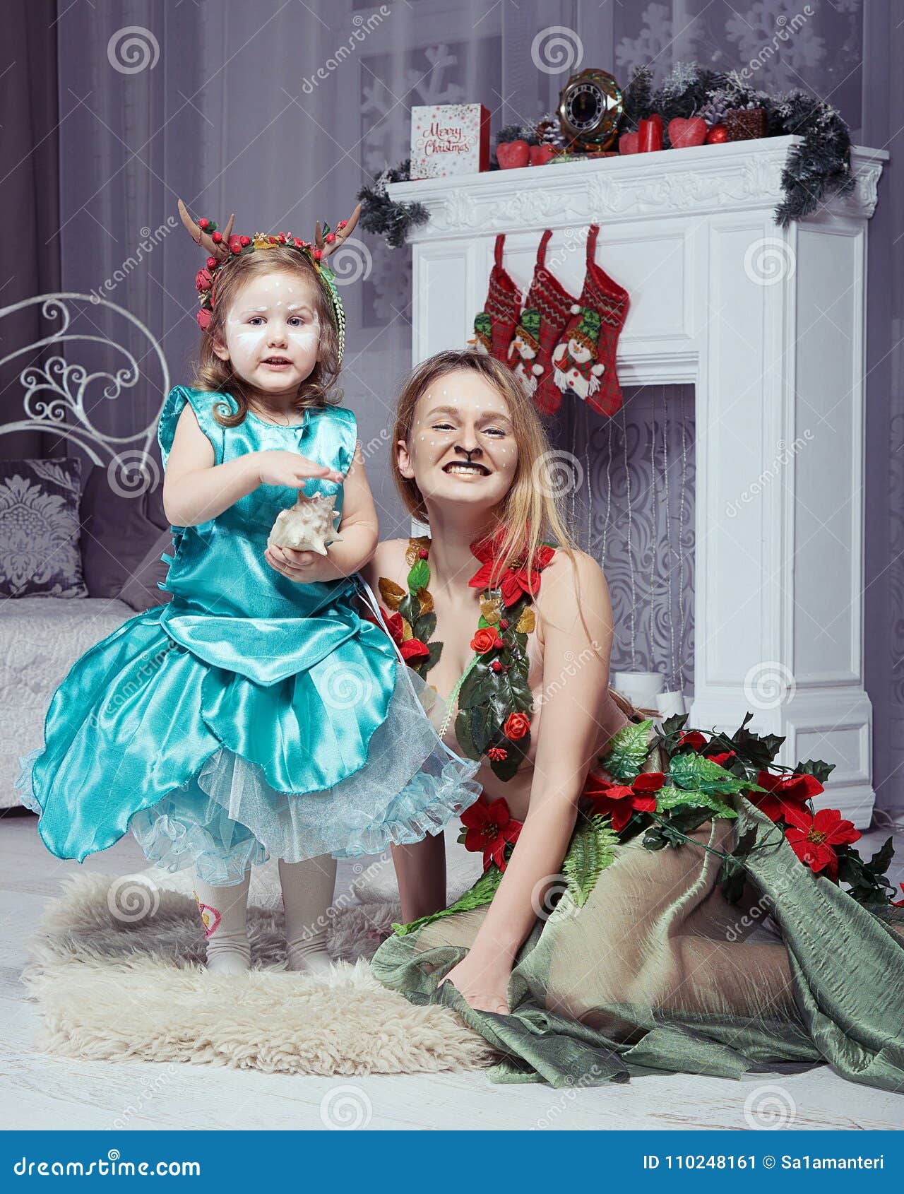 Young Mother And Her Daughter In Fancy Christmas Costumes Stock Image