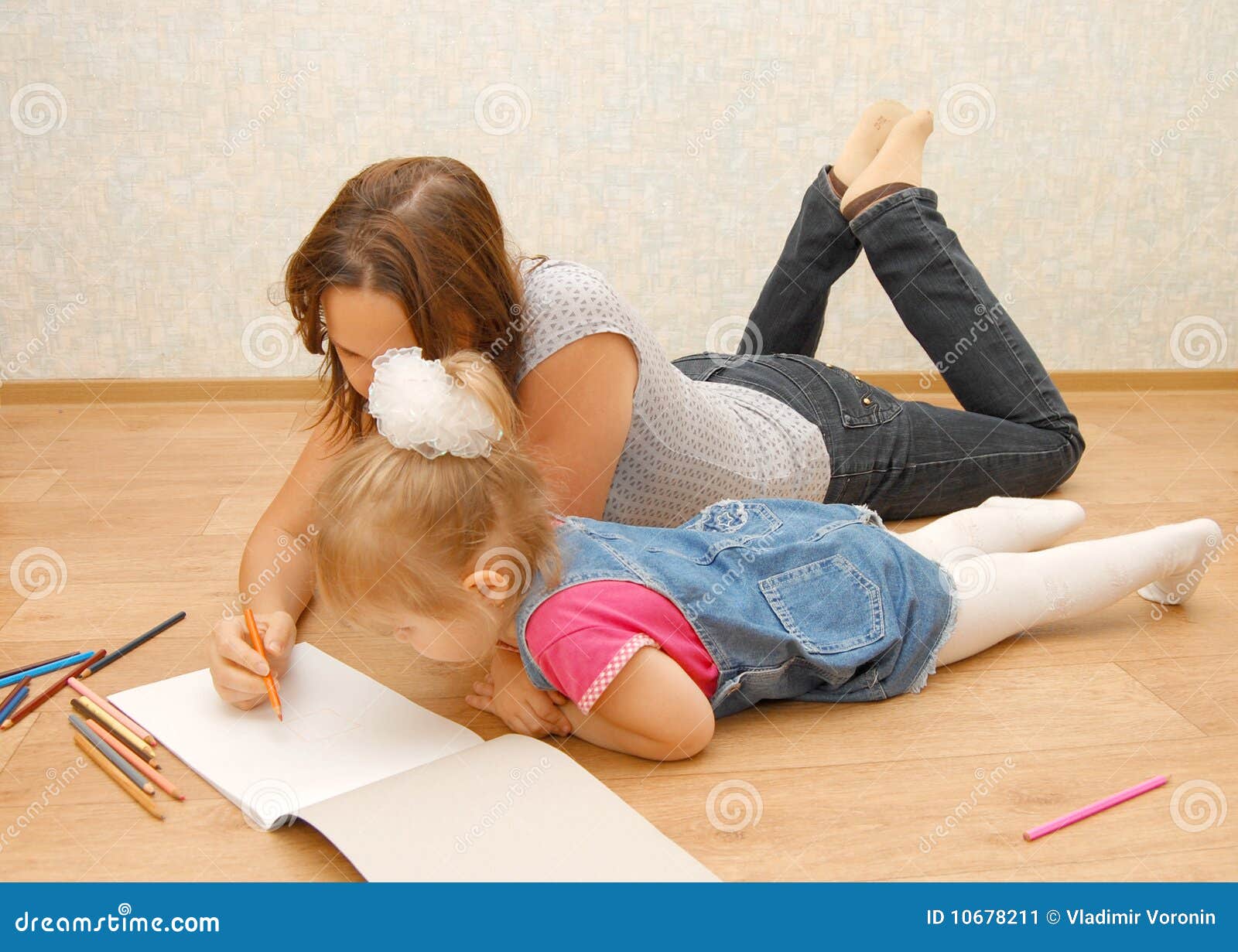 Young Mother with Her Daughter Lying on the Floor Stock Image - Image ...