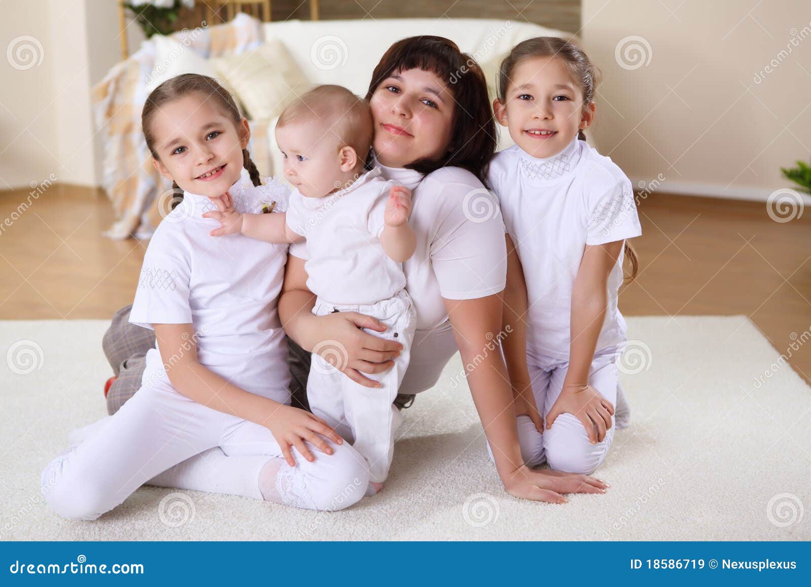 A Young Mother With Her Three Daughters At Home Royalty-Free Stock ...