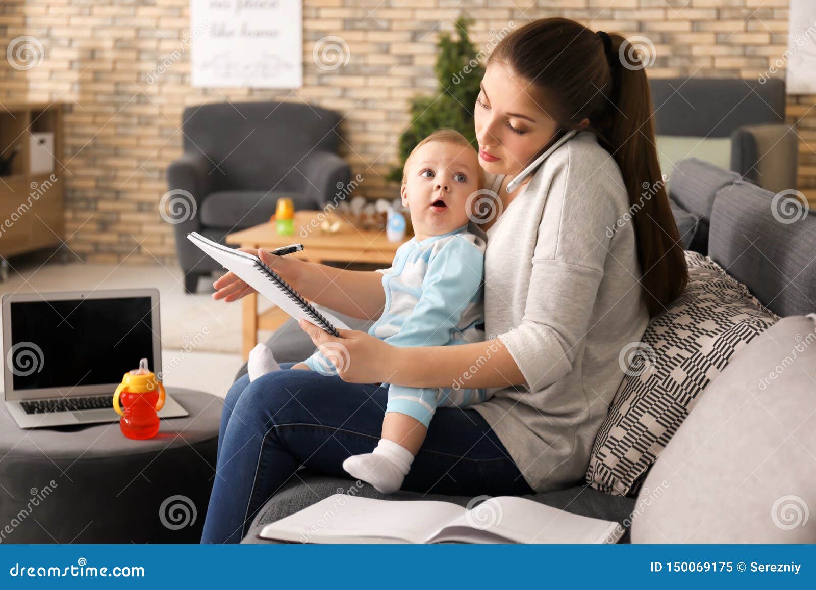 Young Mother Holding Baby while Working at Home Stock Image - Image of ...