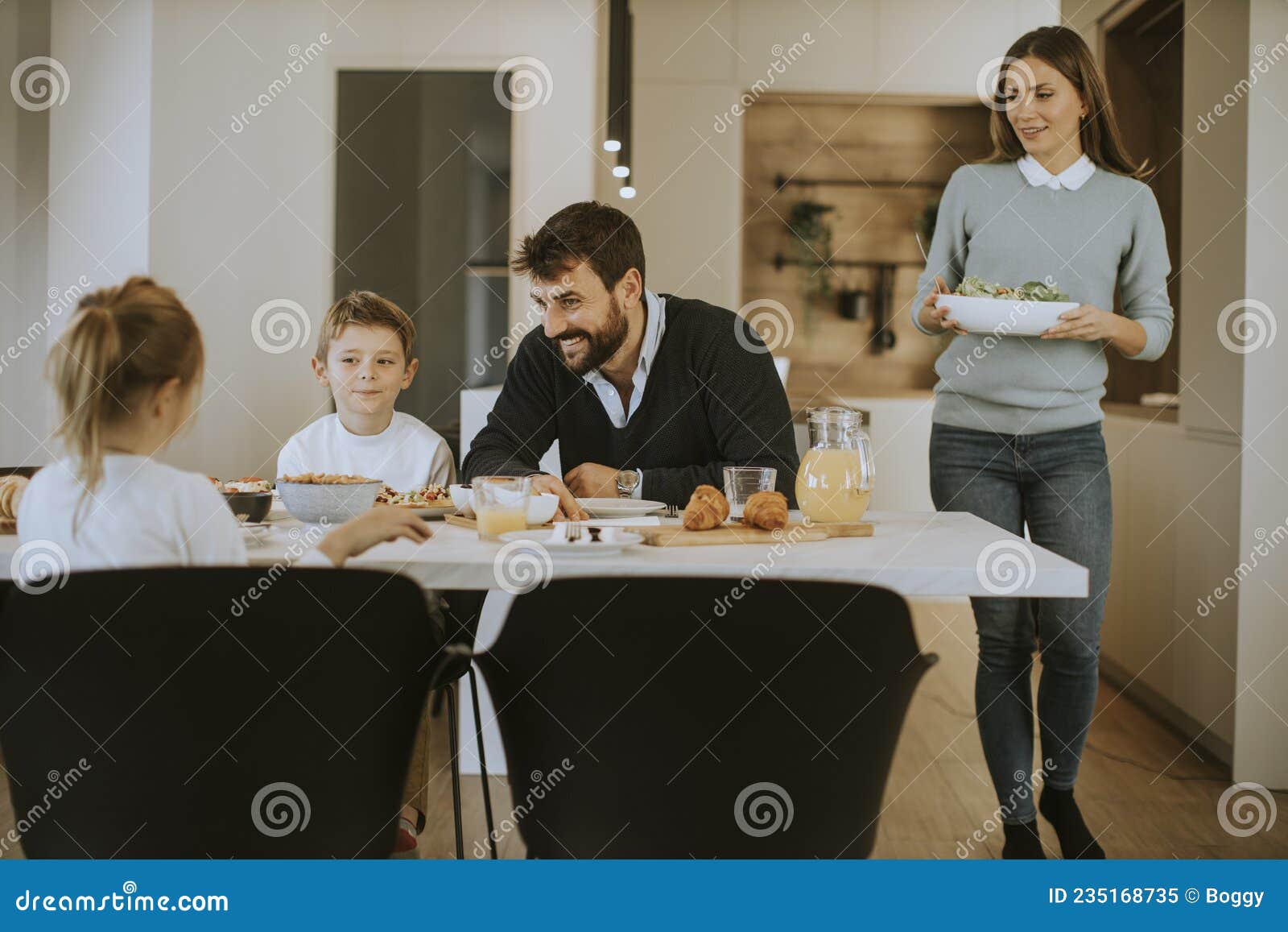 Young Mother Preparing Breakfast for Her Family in the Kitchen Stock ...