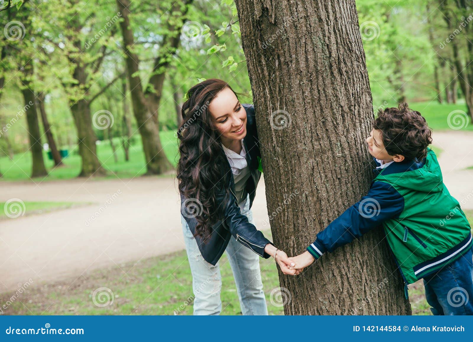 Young Mother and Son Connecting with Tree Stock Photo - Image of hands ...