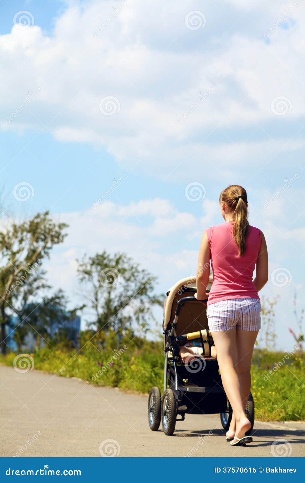 Young Mother with a Stroller Stock Photo - Image of together, sunshine ...