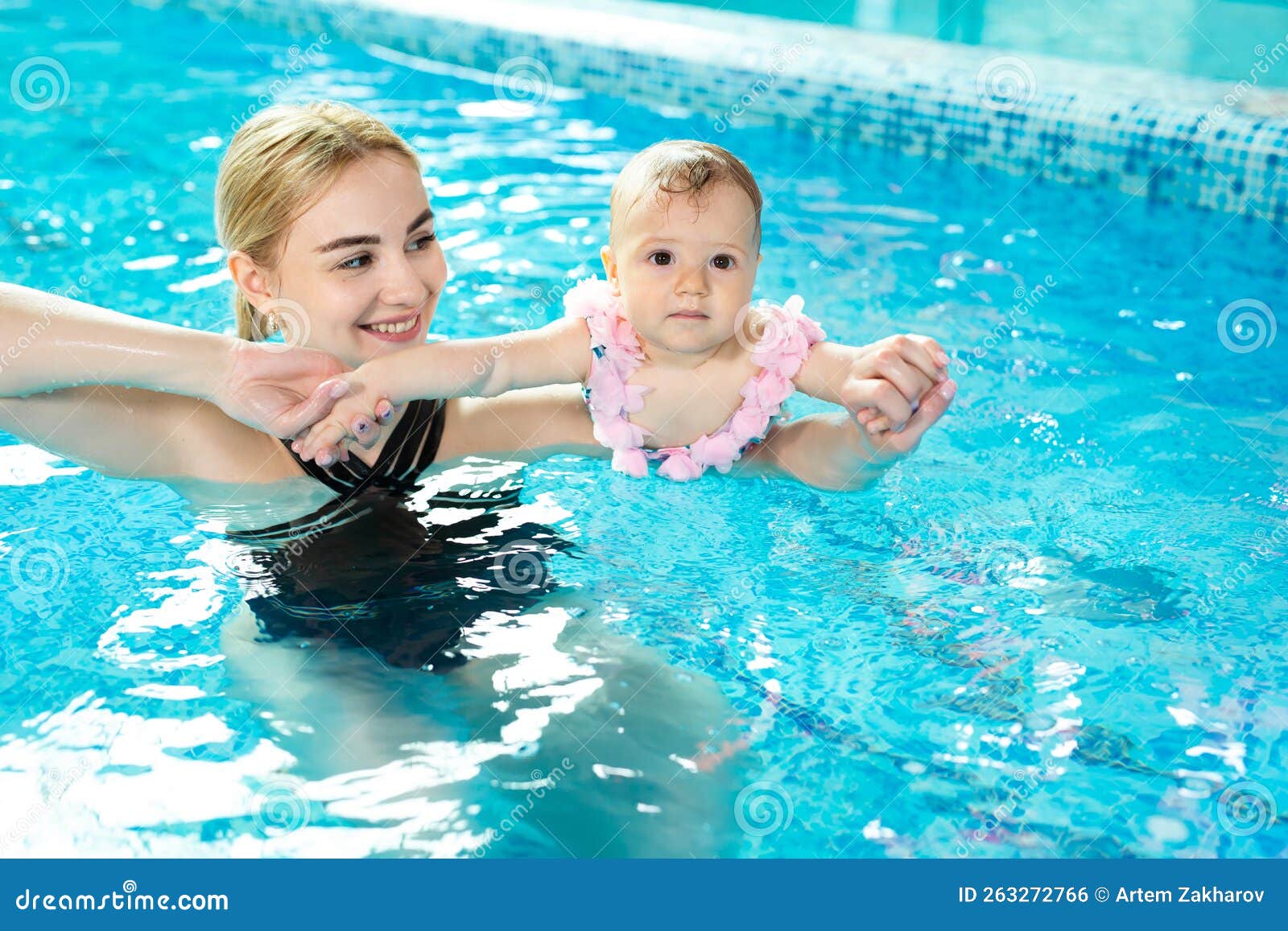 Young Mother, Swimming Instructor and Happy Little Girl in the Pool ... Young Mother, Swimming Instructor and Happy Little Girl in the Pool ...