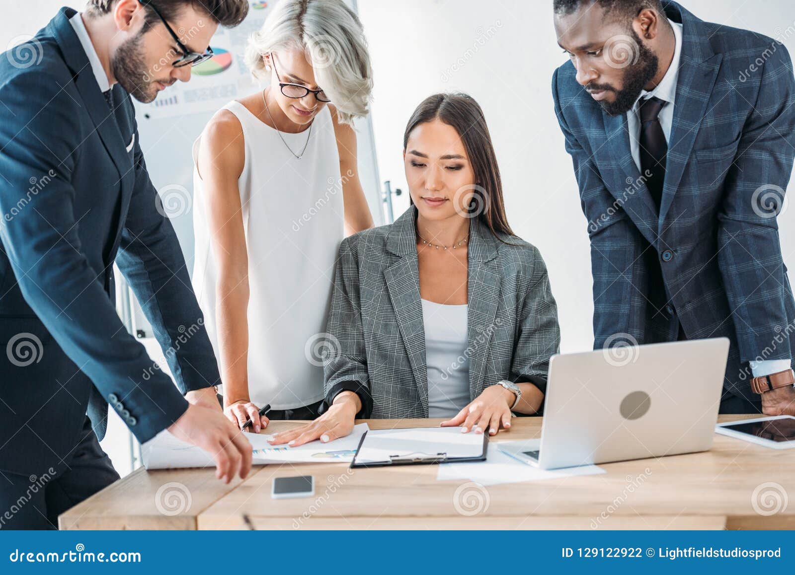Young Multicultural Businesspeople Standing Around Team Leader and ...