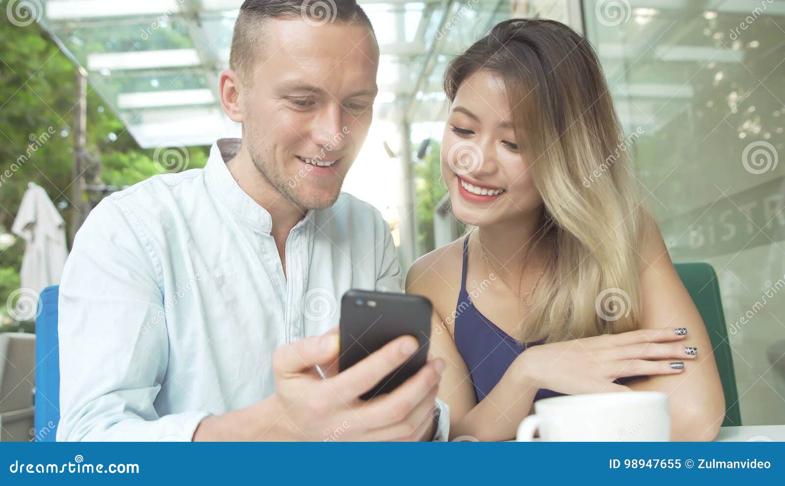 Multicultural Couple Using App on Smartphone Together Stock Image ...