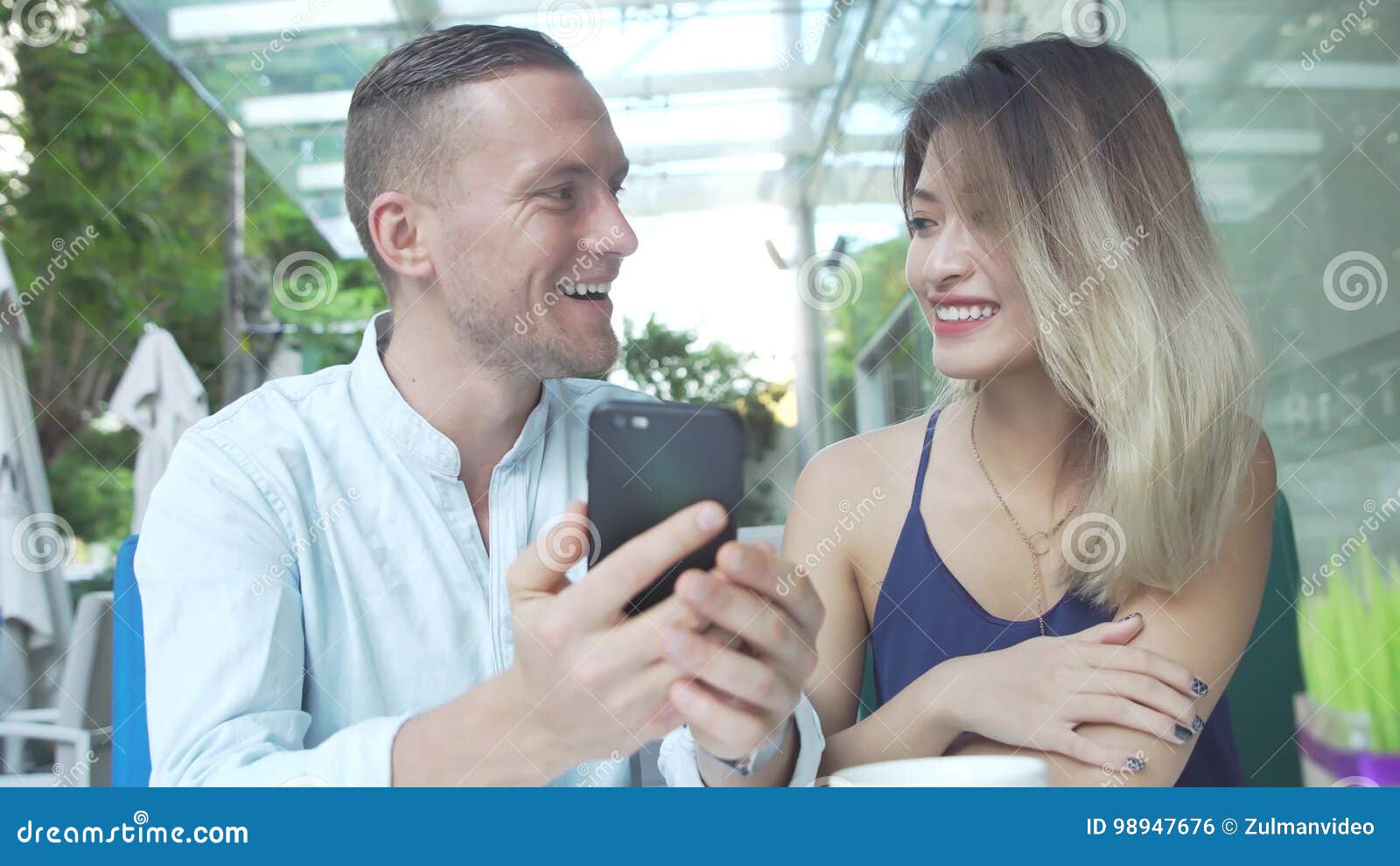Multicultural Couple Using App on Smartphone Together Stock Photo ...