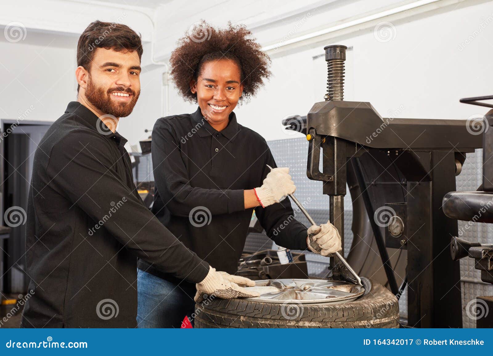 Mechatronics Engineer with Apprentice at the Tire Changer Stock Image ...