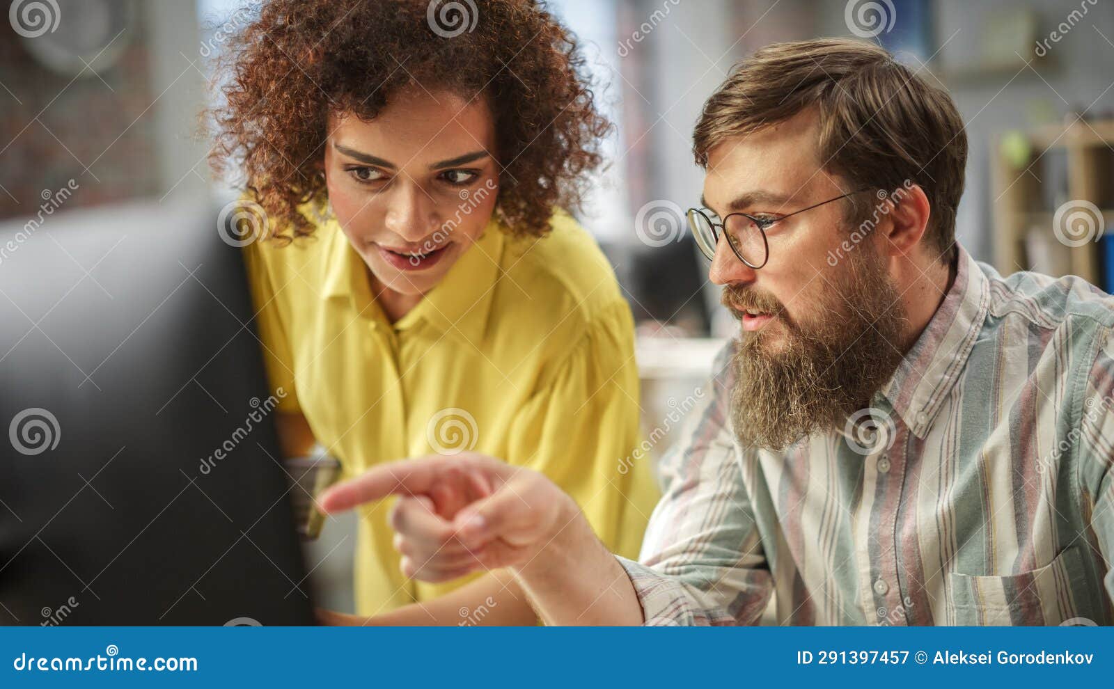 Young Multiethnic Creative Team Brainstorming and Problem Solving, Using Computers in Modern ...