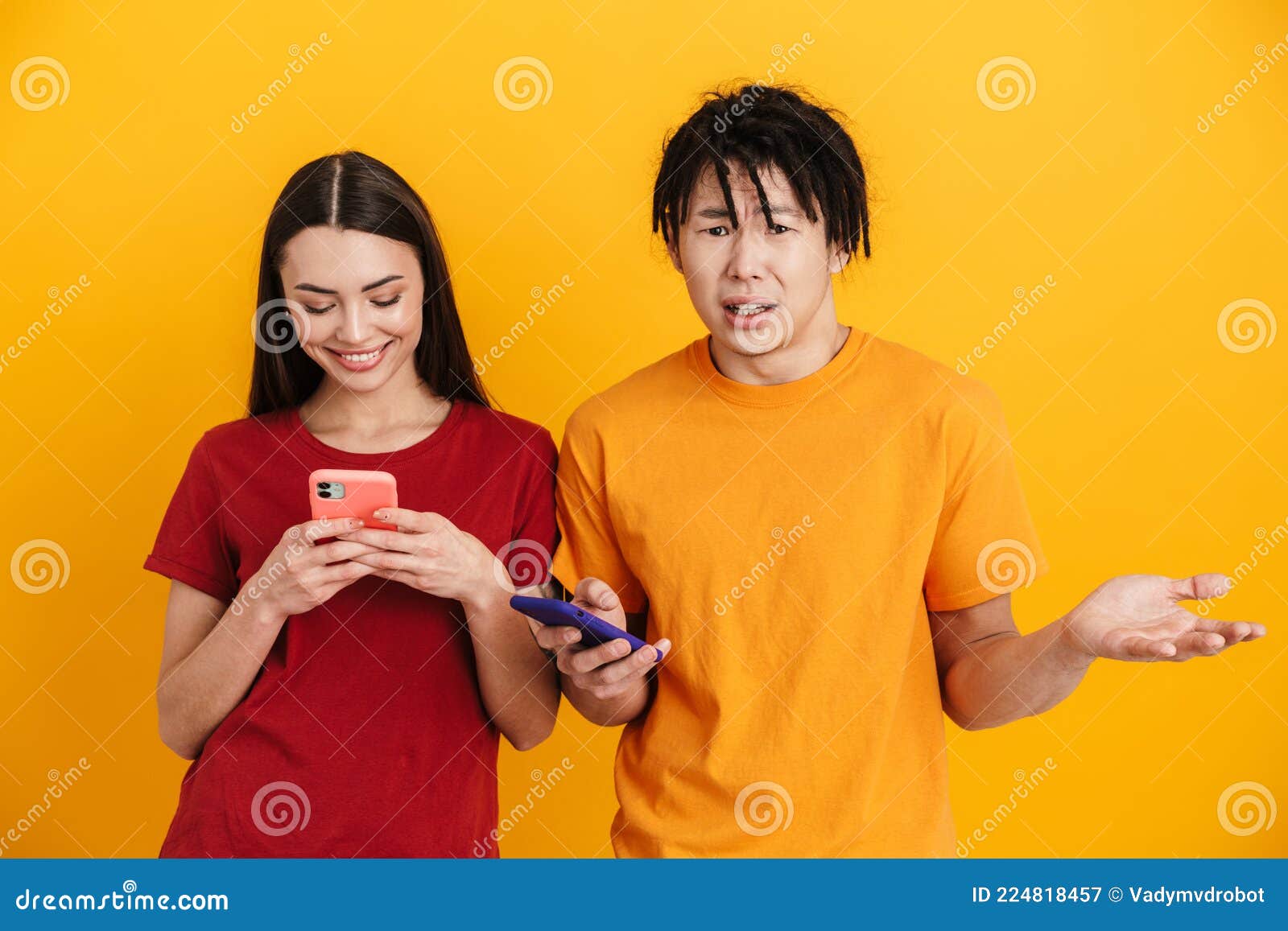 Young Multiracial Couple Posing and Using Mobile Phones Stock Image ...