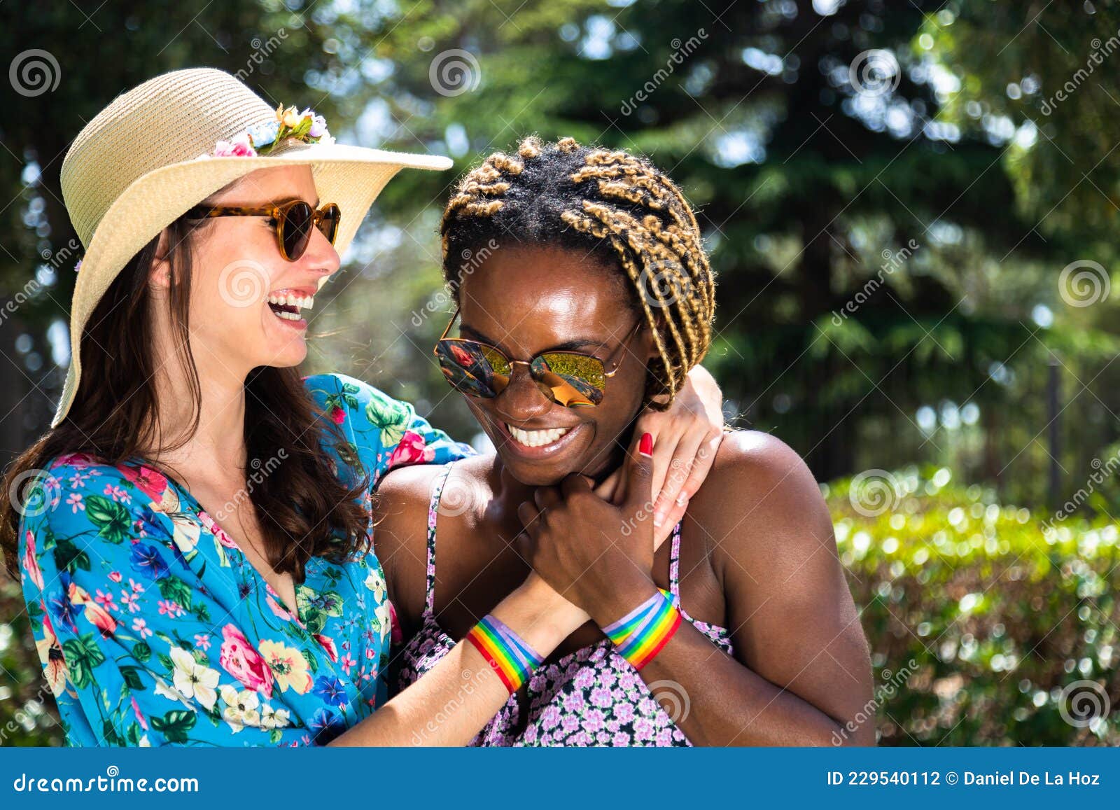 Young Multiracial Lesbian Couple Laugh Together During Vacations Stock