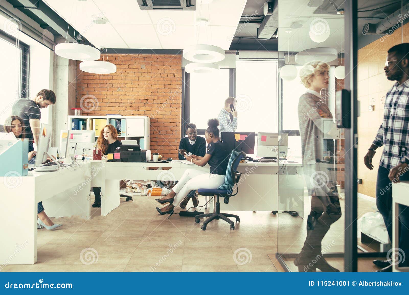 Young Multy Ethnic People Working in Different Ways in the Light Office ...