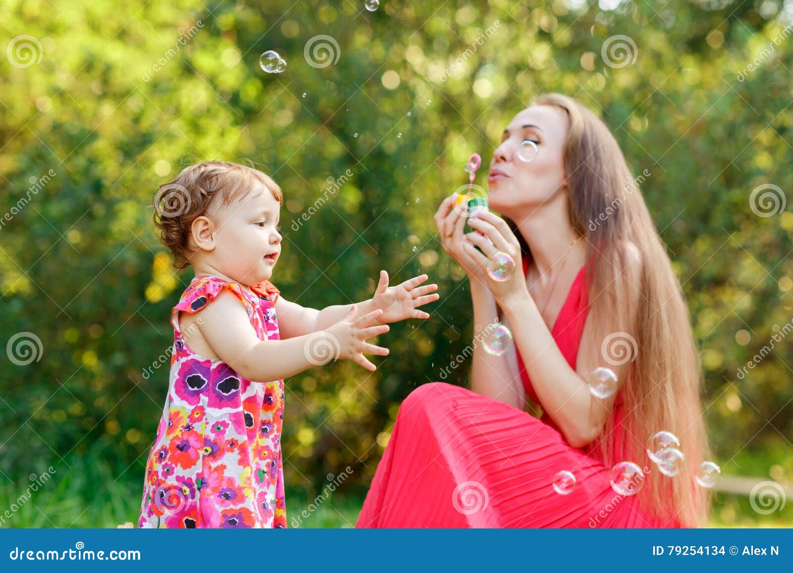 Young Mum with Daughter Blowing Soap Bubbles Stock Photo - Image of ...
