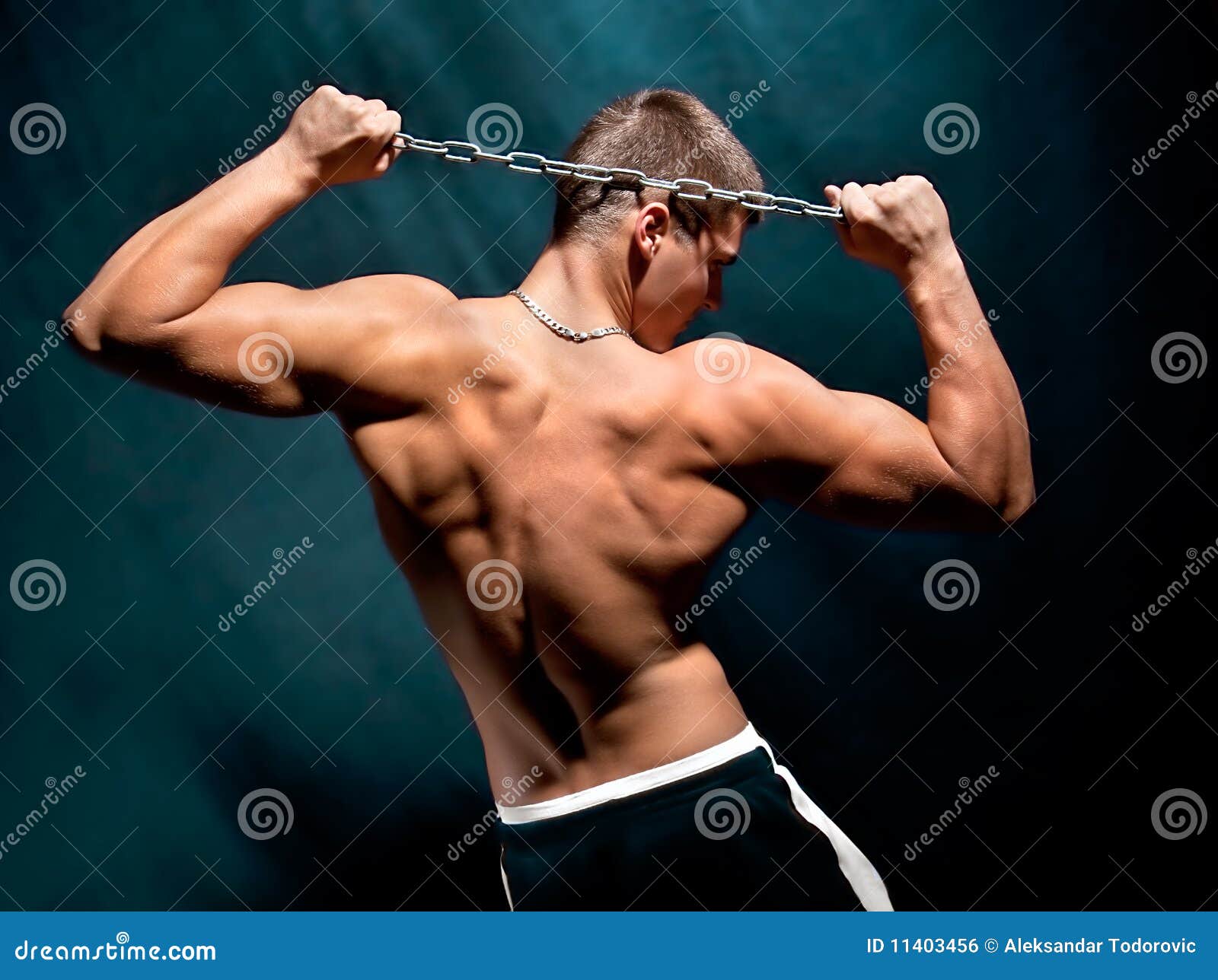 Young Muscular Man with a Chain Isolated on Dark Stock Photo - Image of ...