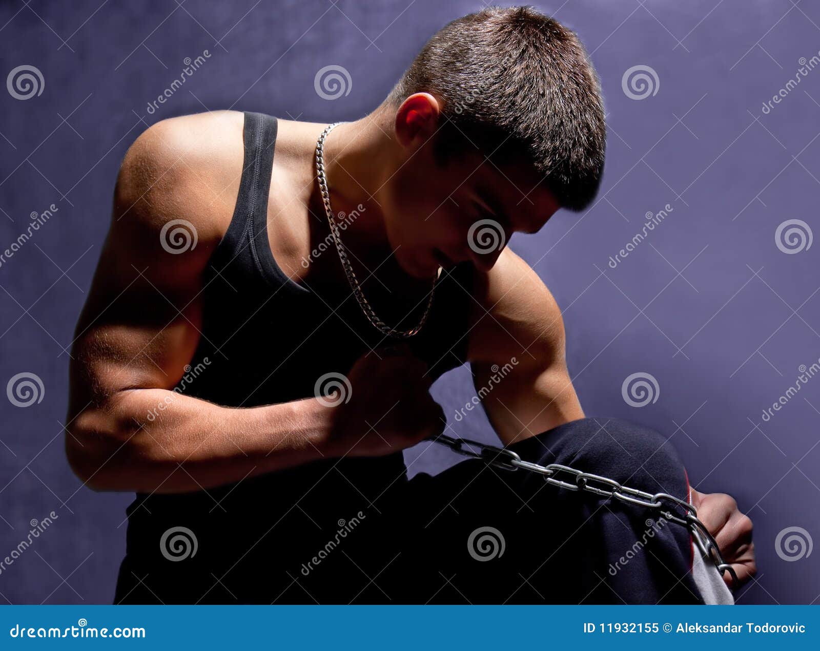 Young Muscular Man with a Chain Isolated on Dark Stock Image - Image of ...