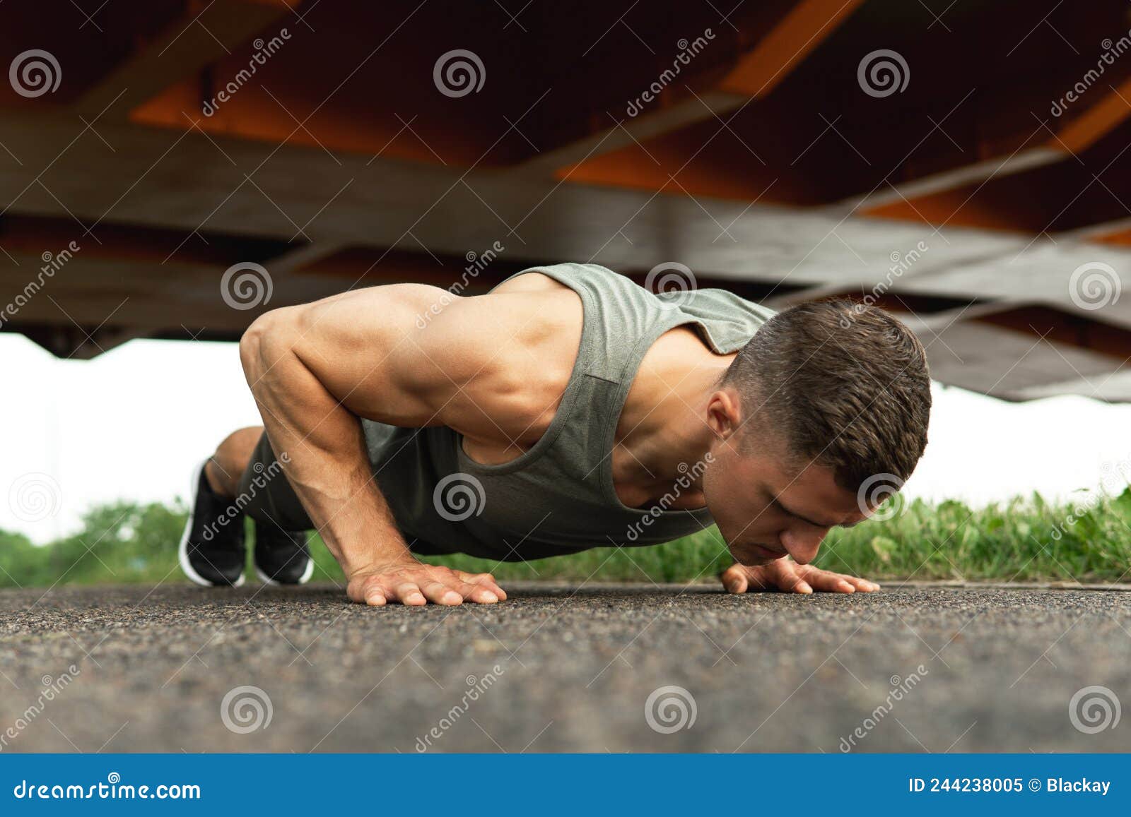 Muscular Man is Doing Push-ups during Calisthenic Workout on a Street ... Muscular Man is Doing Push-ups during Calisthenic Workout on a Street ...