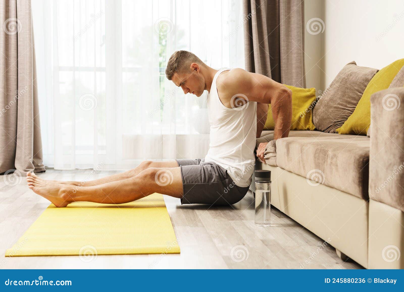 Man Doing Triceps Dips on Edge of Sofa during Home Workout Stock Photo ...