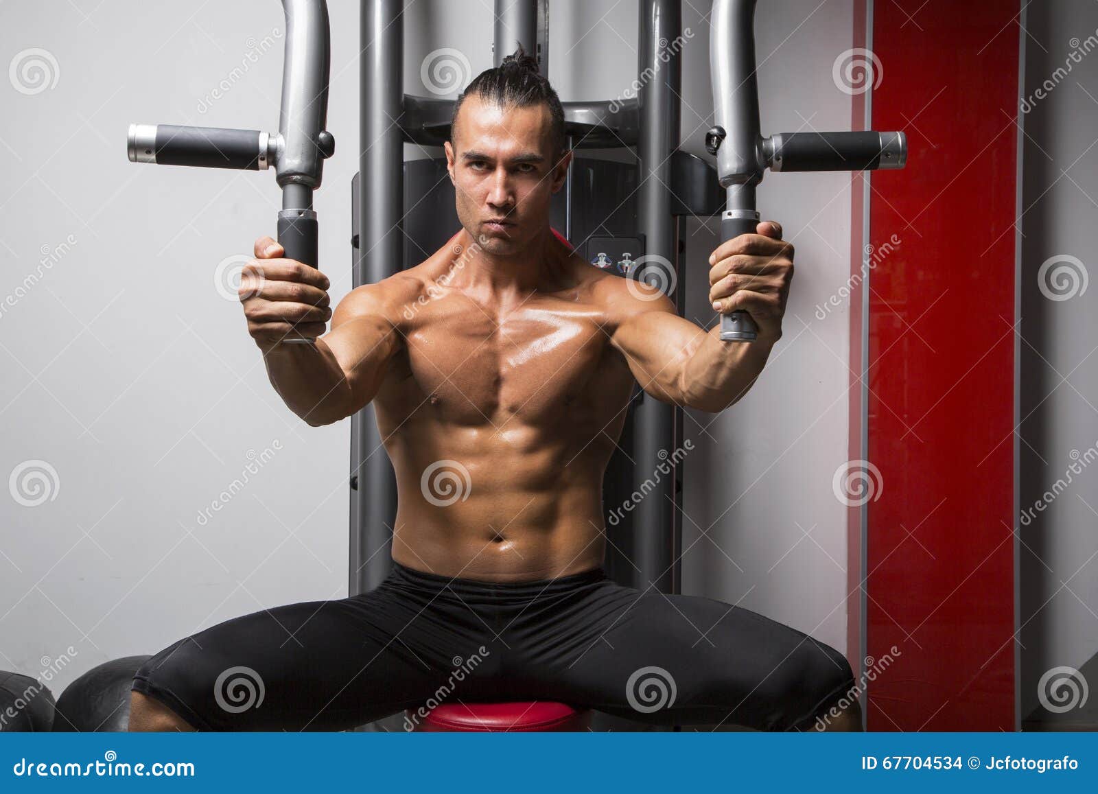Young muscular man in gym stock photo. Image of bodybuilding - 67704534